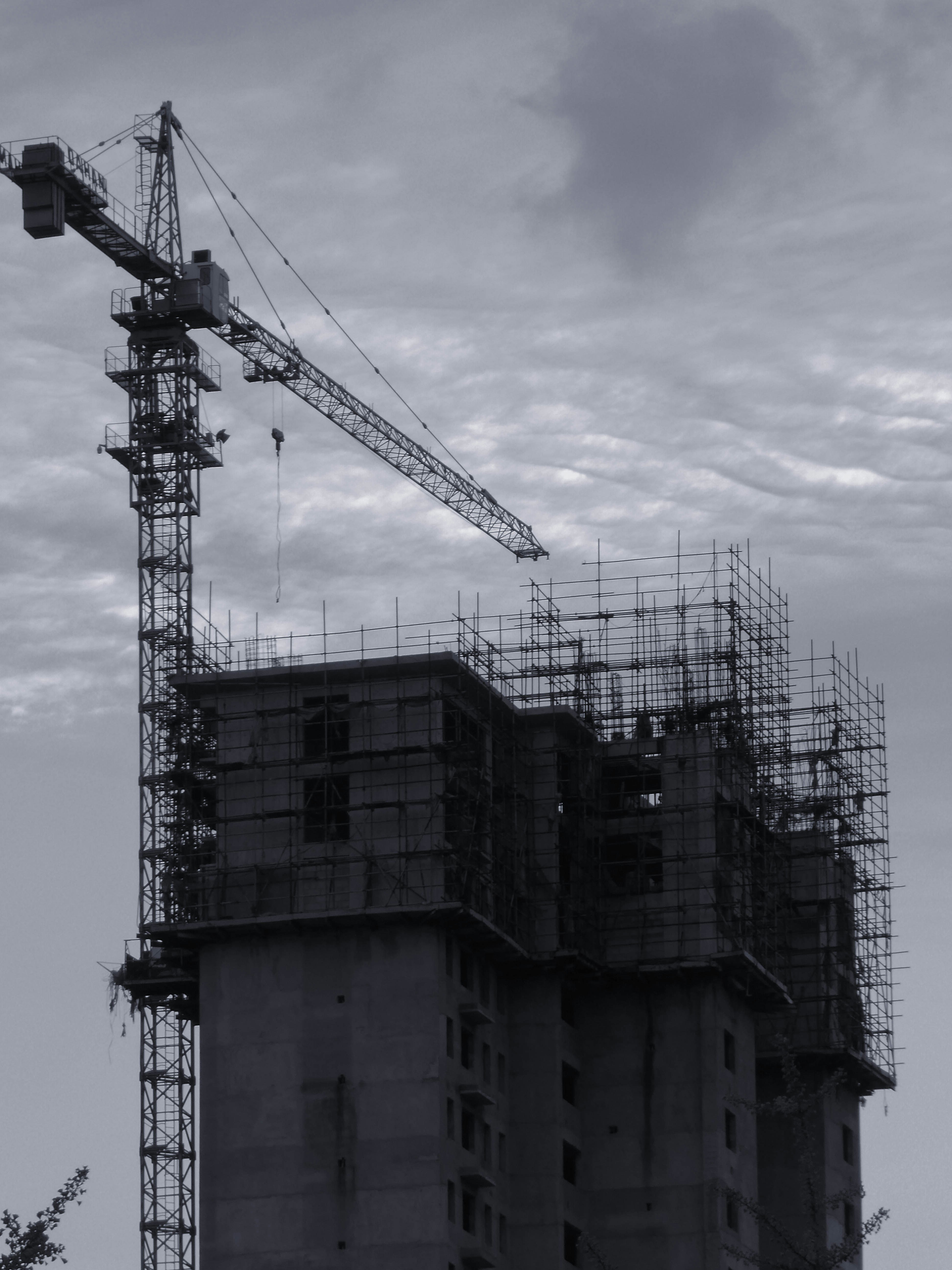 Cranes Carve the Sky: A Towering Construction at Dusk