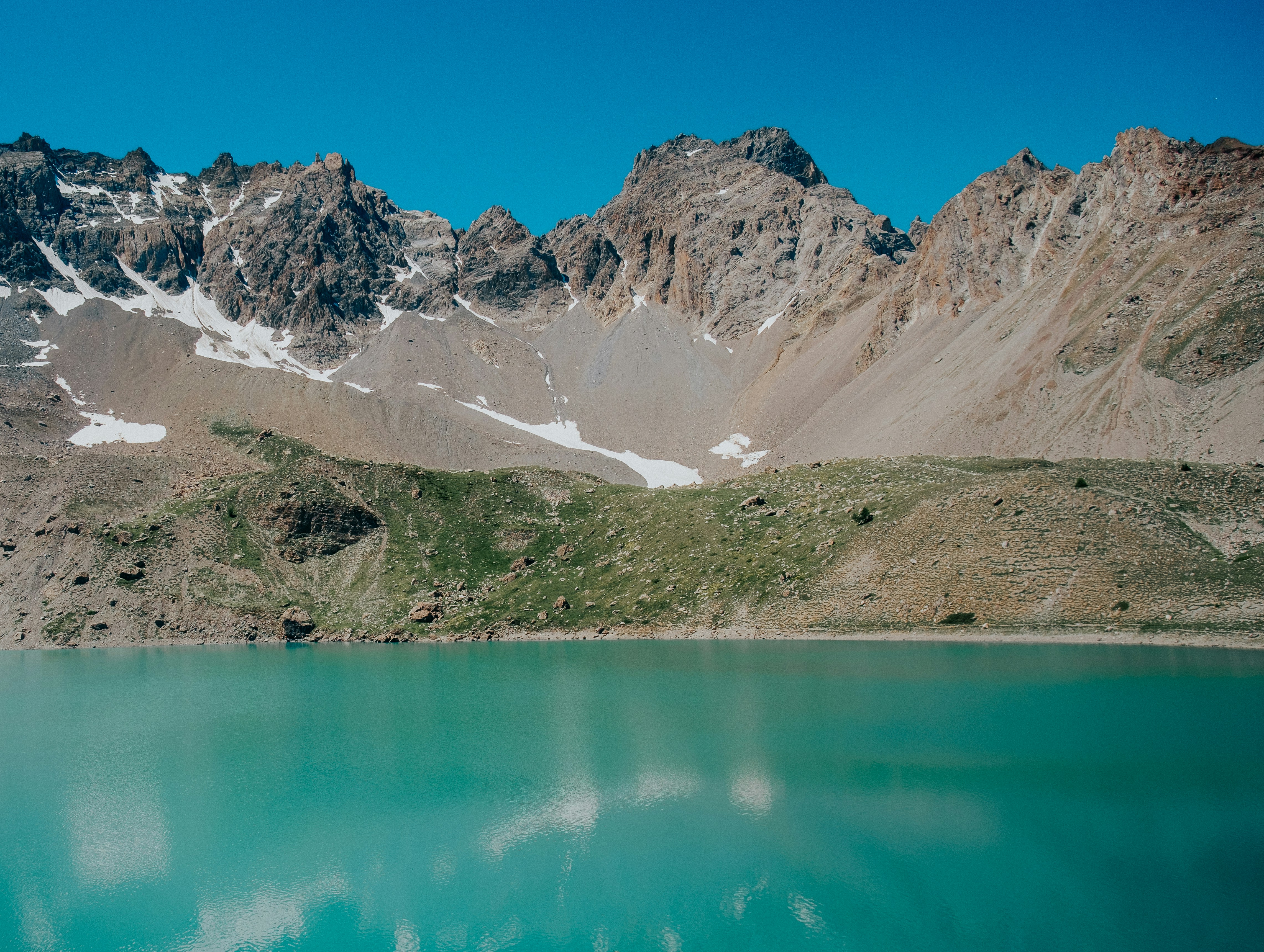 Emerald Mirror: Mountain Lake Under a Clear Sky