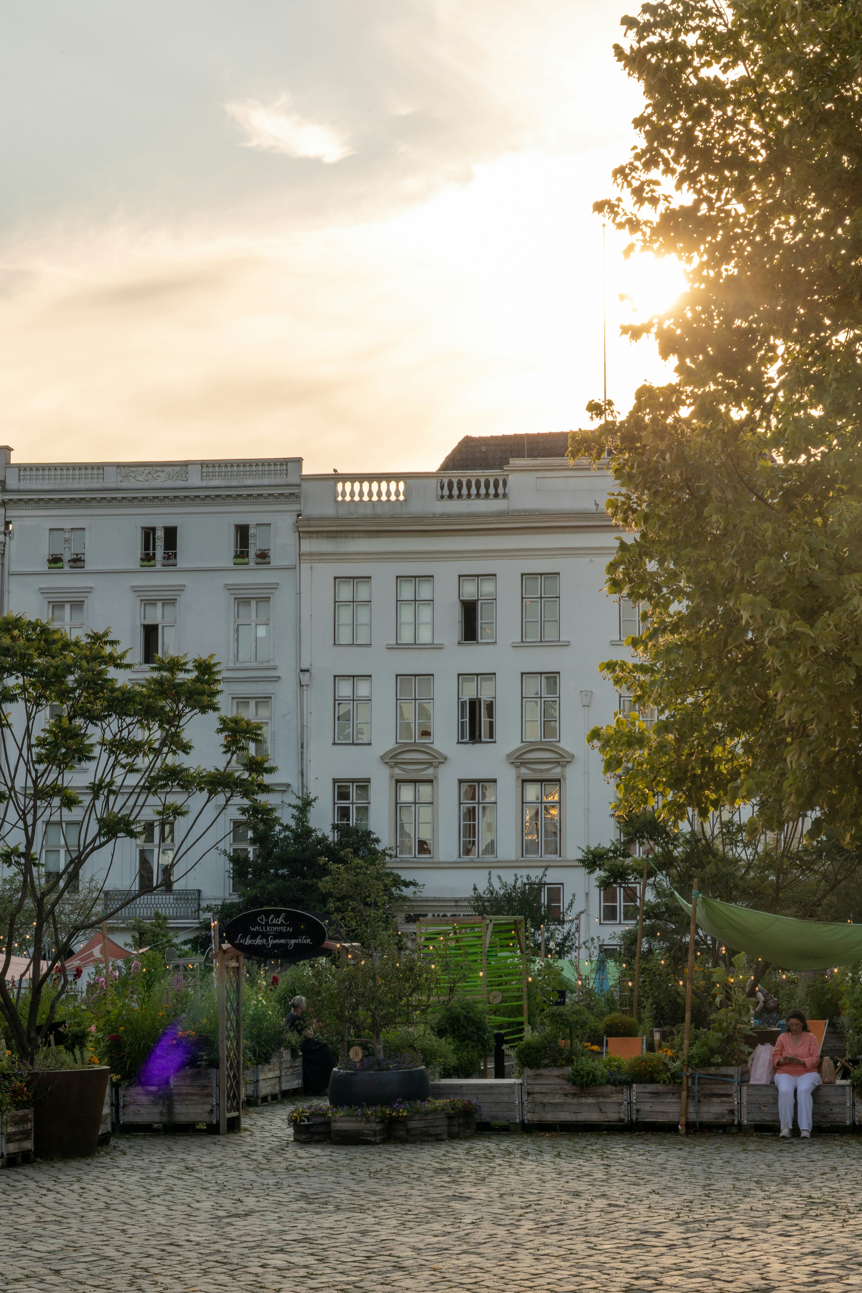 Evening Sun Over a Courtyard of White Townhouses