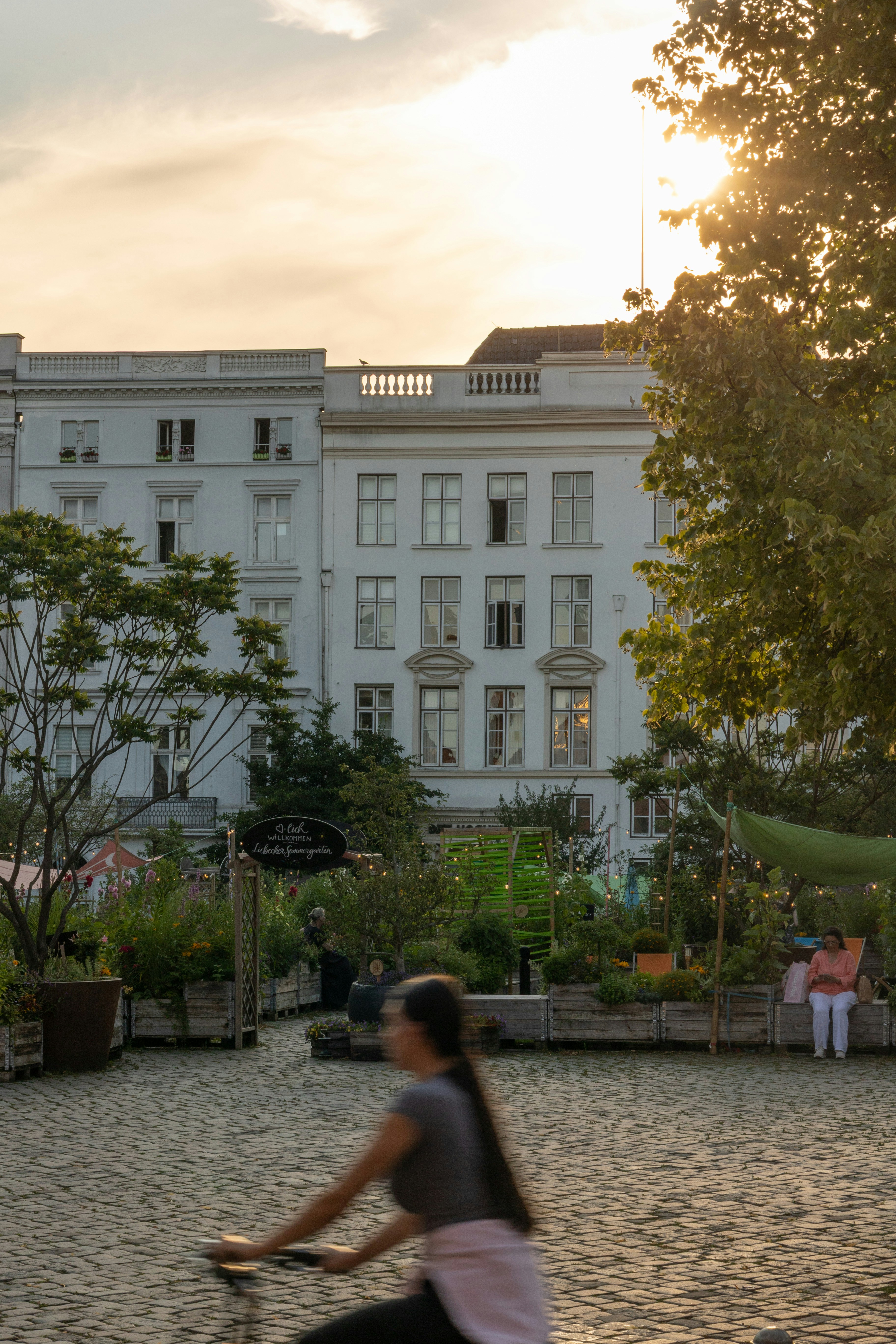 Sunlit Grand Street: A Quiet Moment by the White Facades
