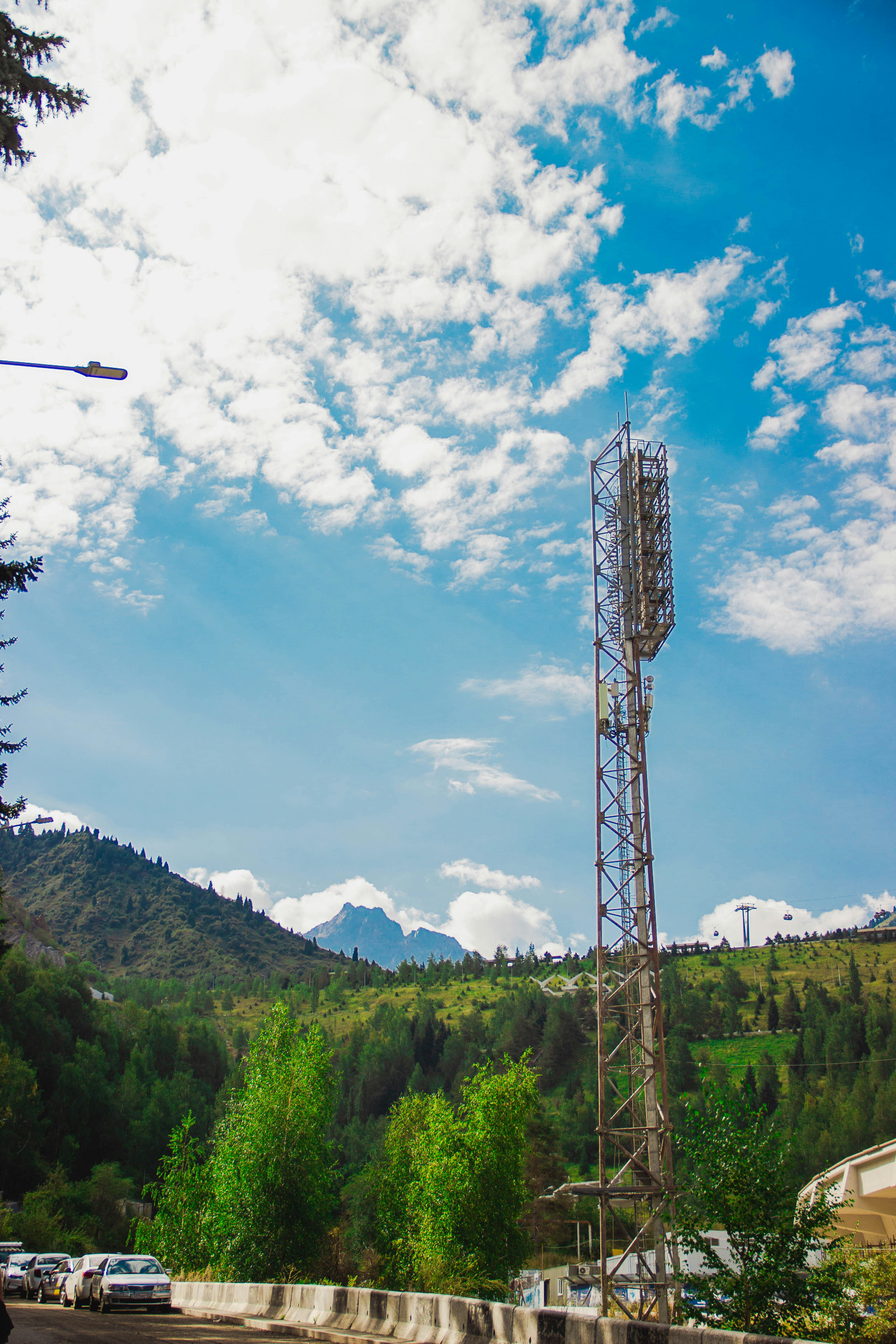 Silhouette of a transmission tower against a alpine sky