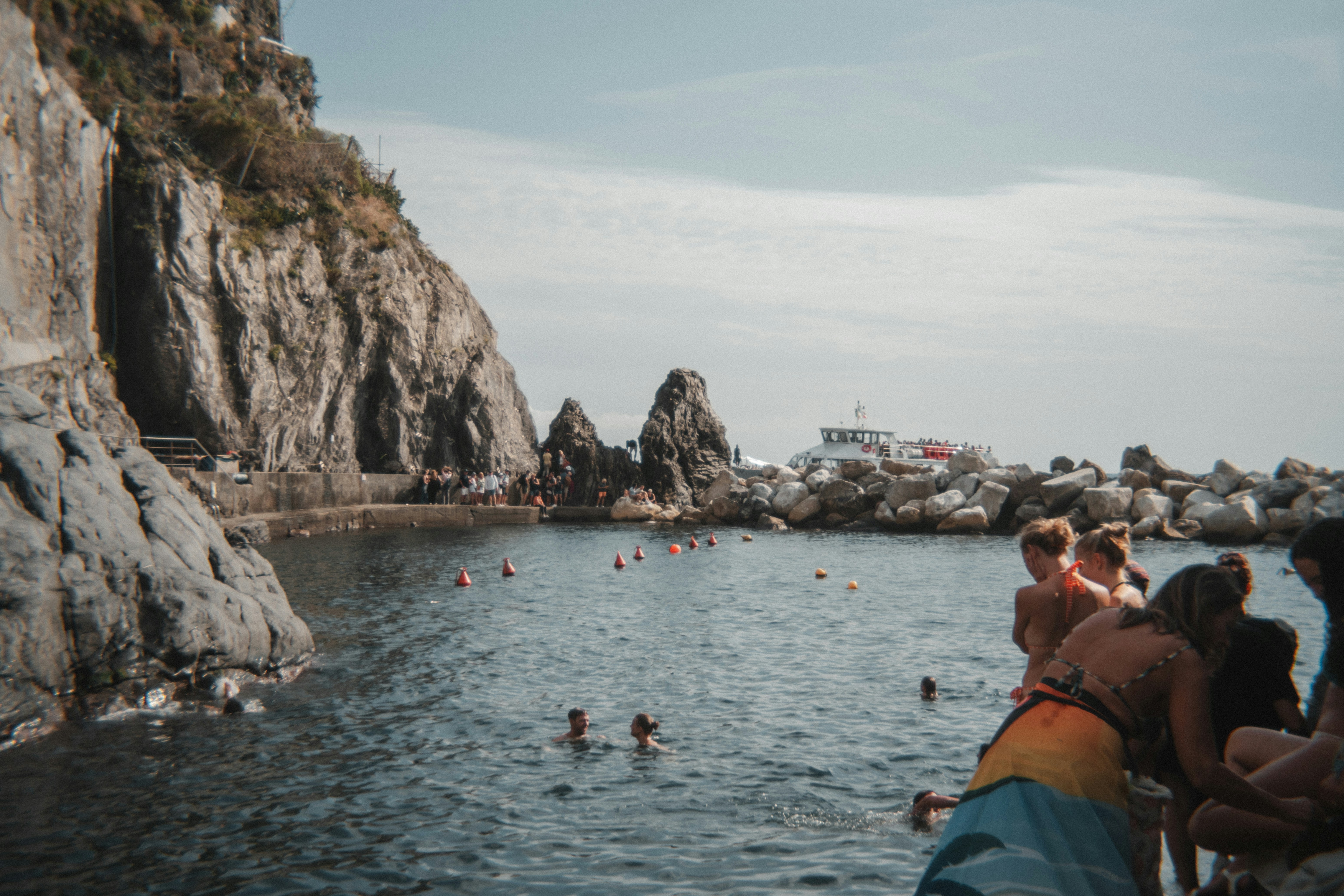 Rugged Cove Ferryline: People Gather at Coastal Rock Barrier