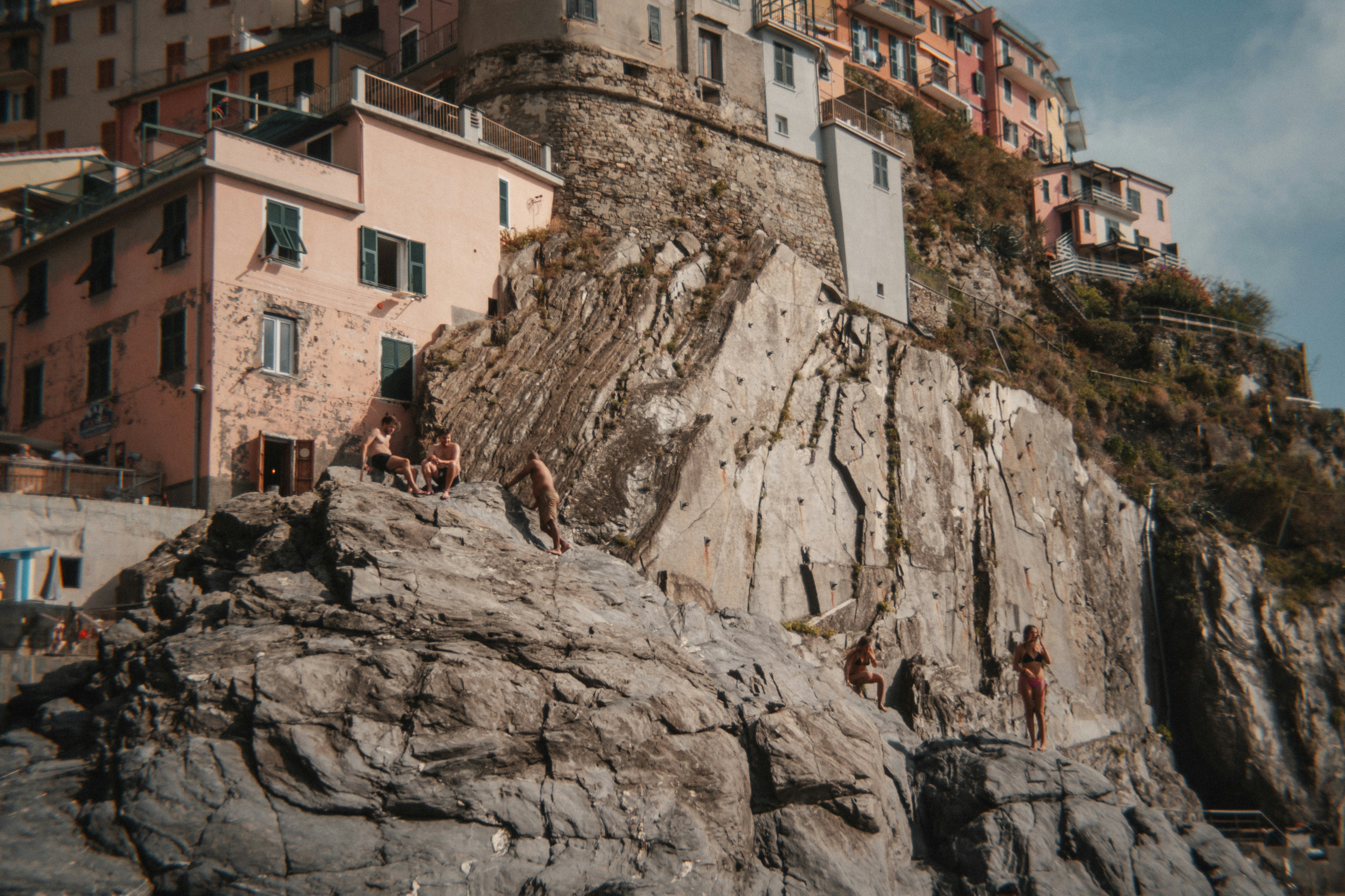 Cliffside Village: Sunlit pastel houses over rugged shoreline
