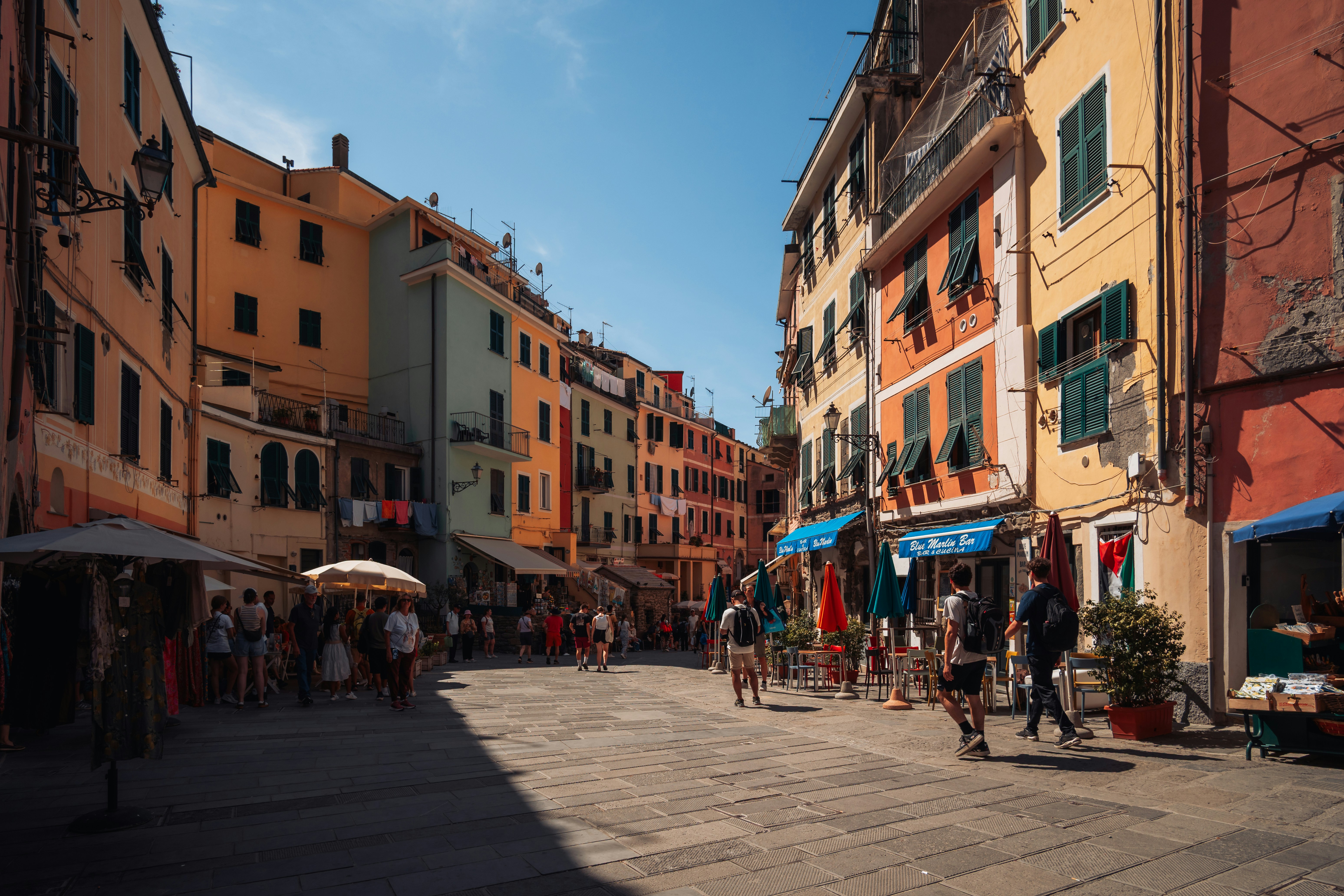 Colorful Piazza Corridor: Sunlit Street Between Warmed Facades