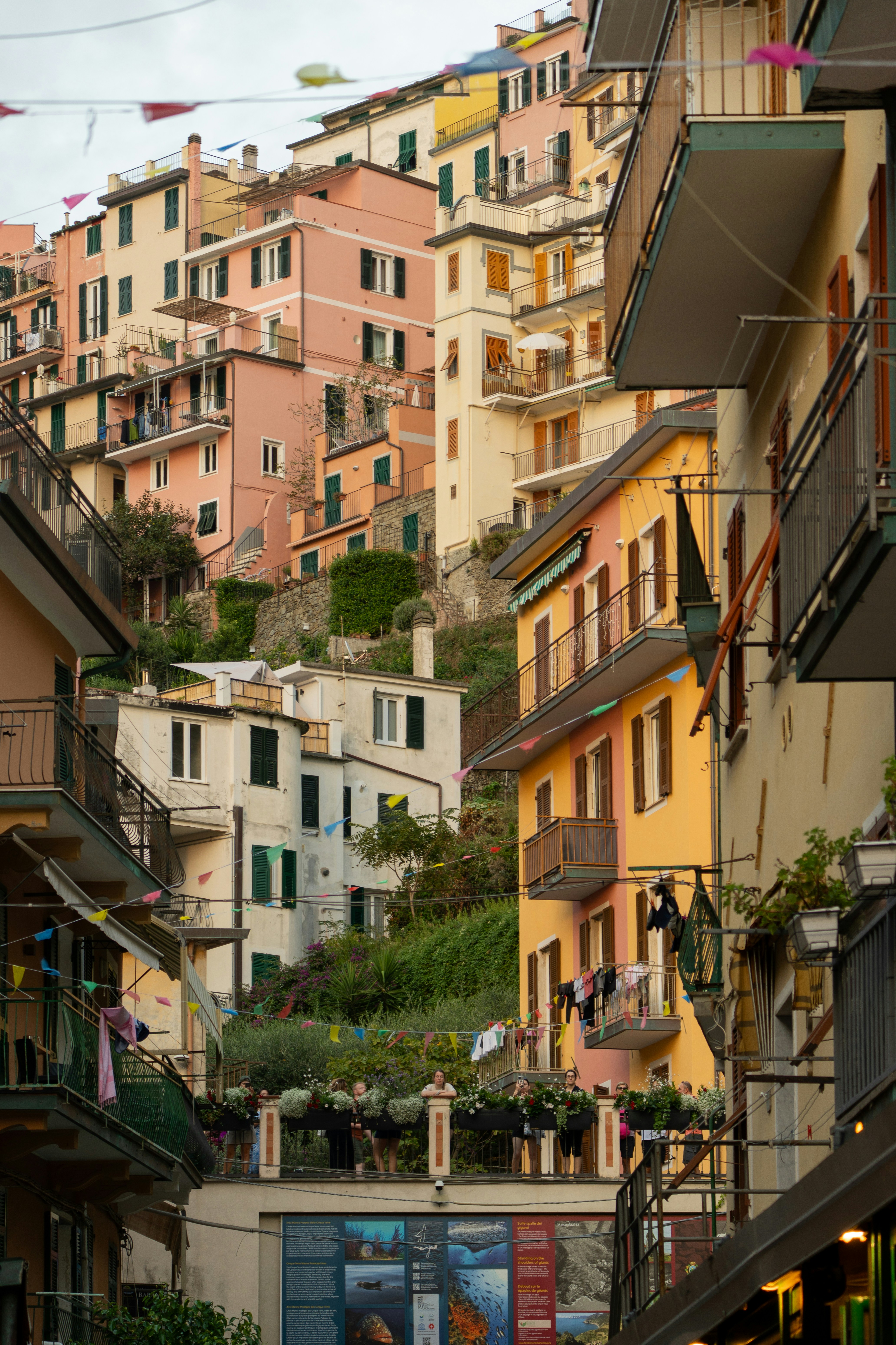 Colorful hillside streetscape: sunlit facades and fluttering bunting
