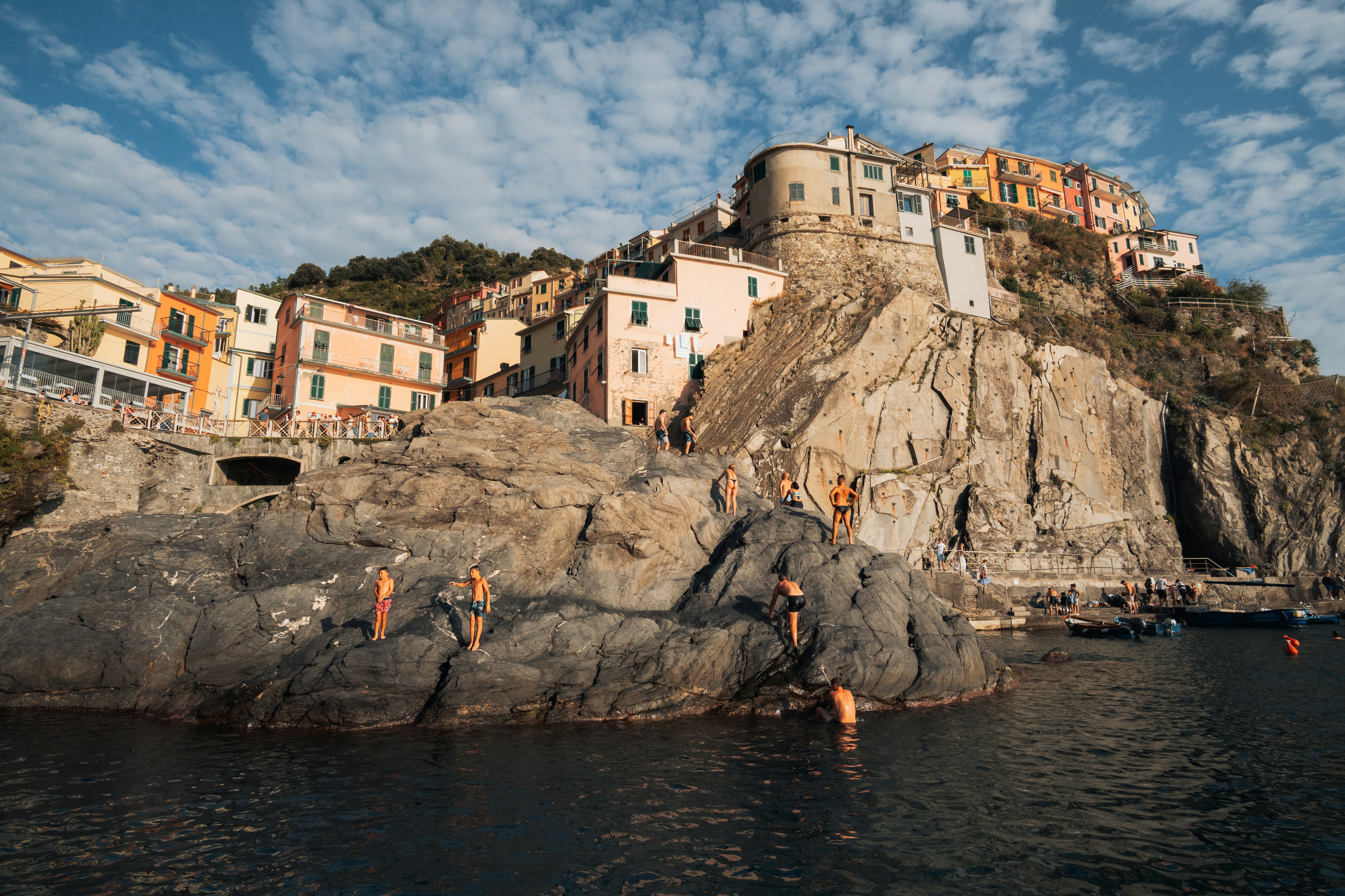 Colorful cliffside village perched above crystal waters