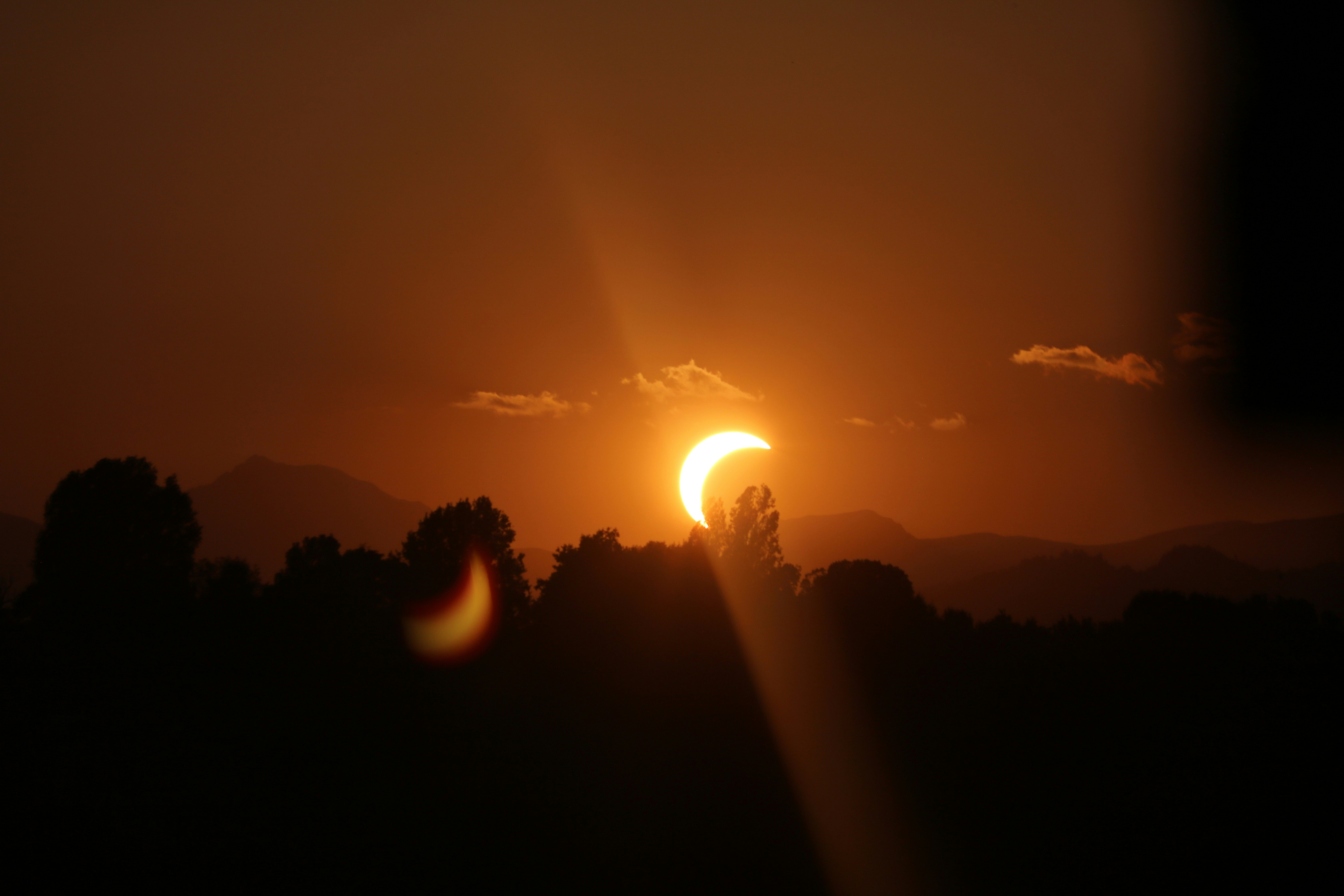 Sun Halo on the Ridge: A Quiet Distant Sunset