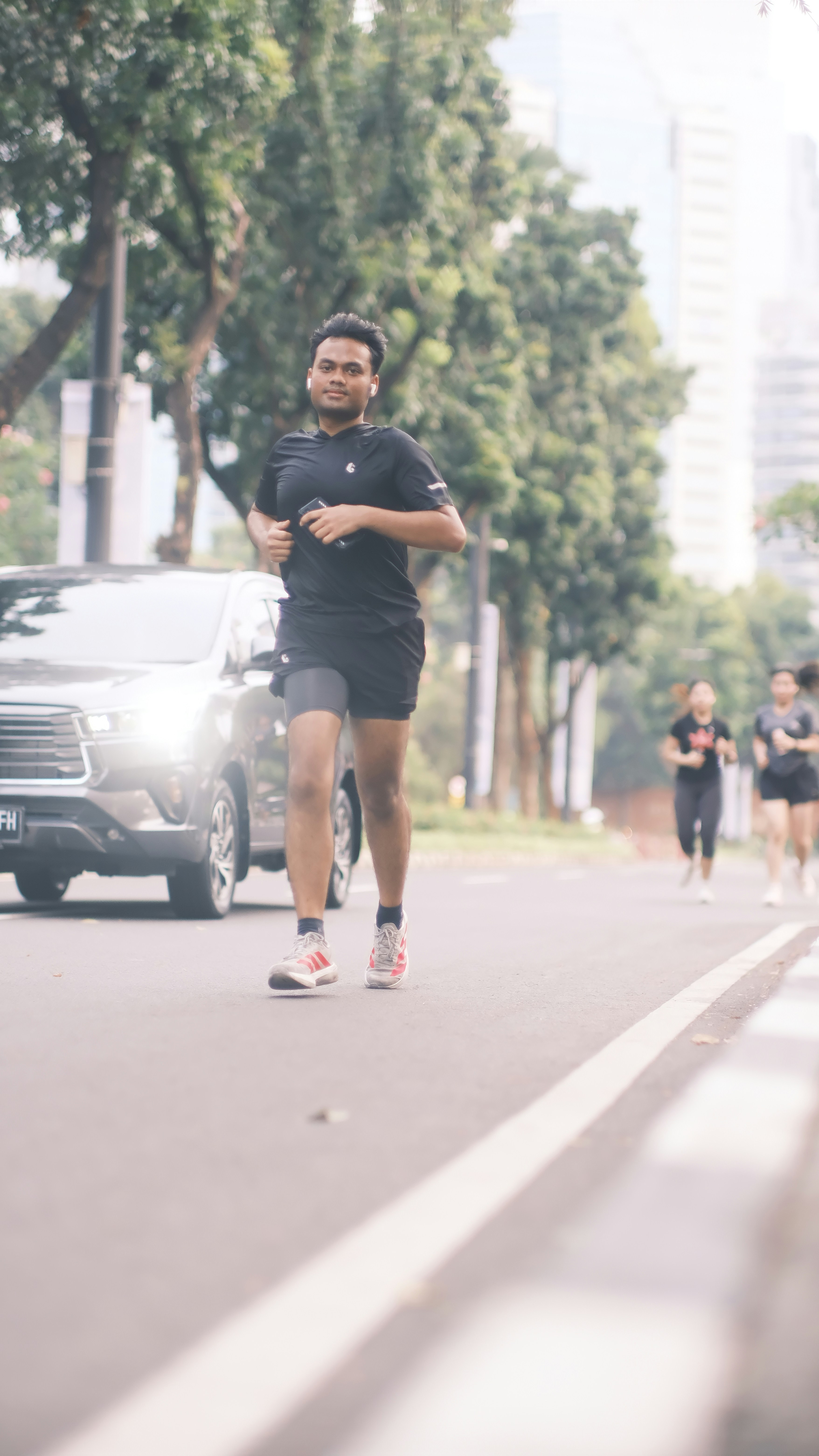 Runner in Black: City Street Quest at Dawn