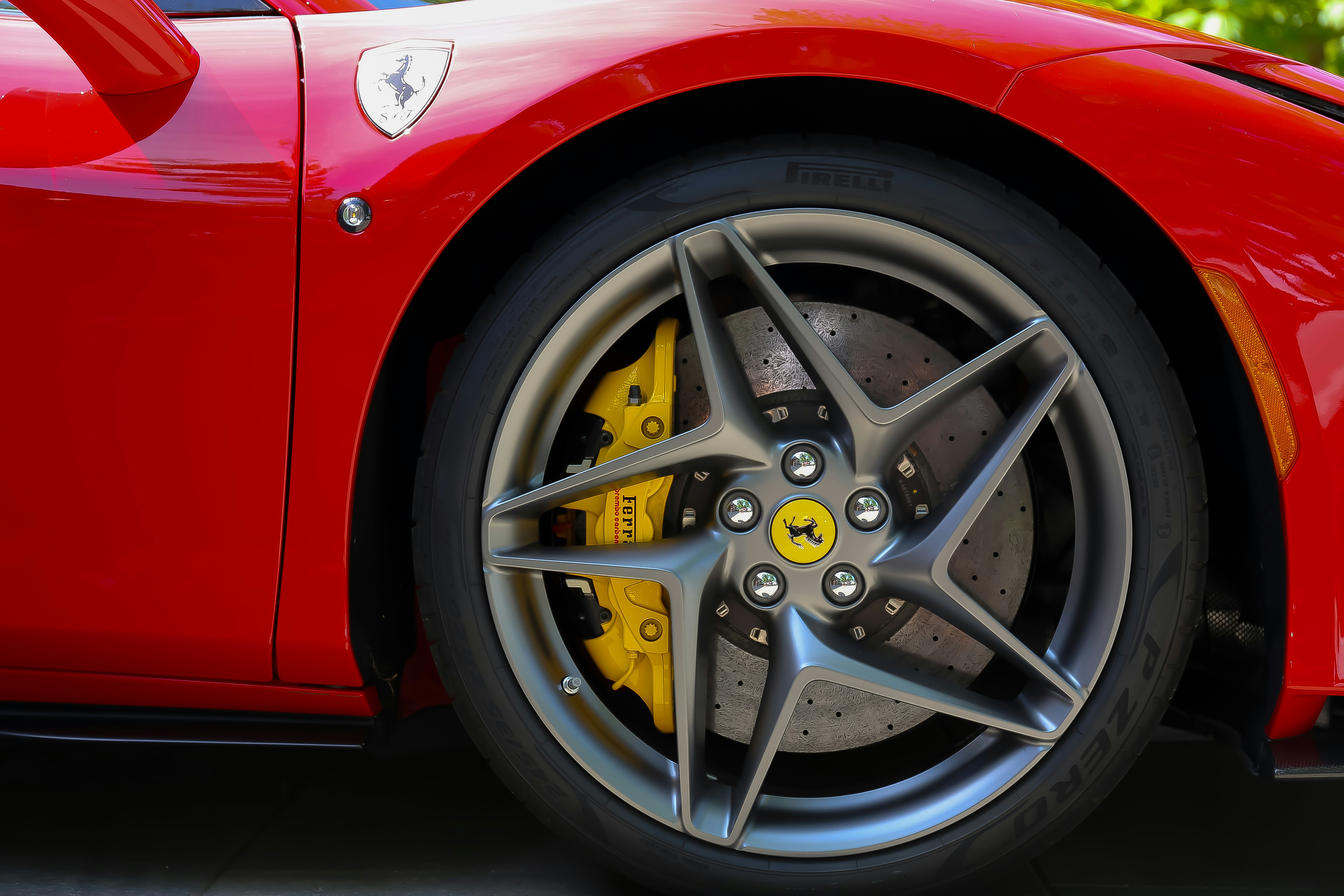 Ferrari Master-Detail: Yellow Caliper and Alloy Wheel Under Red Panel