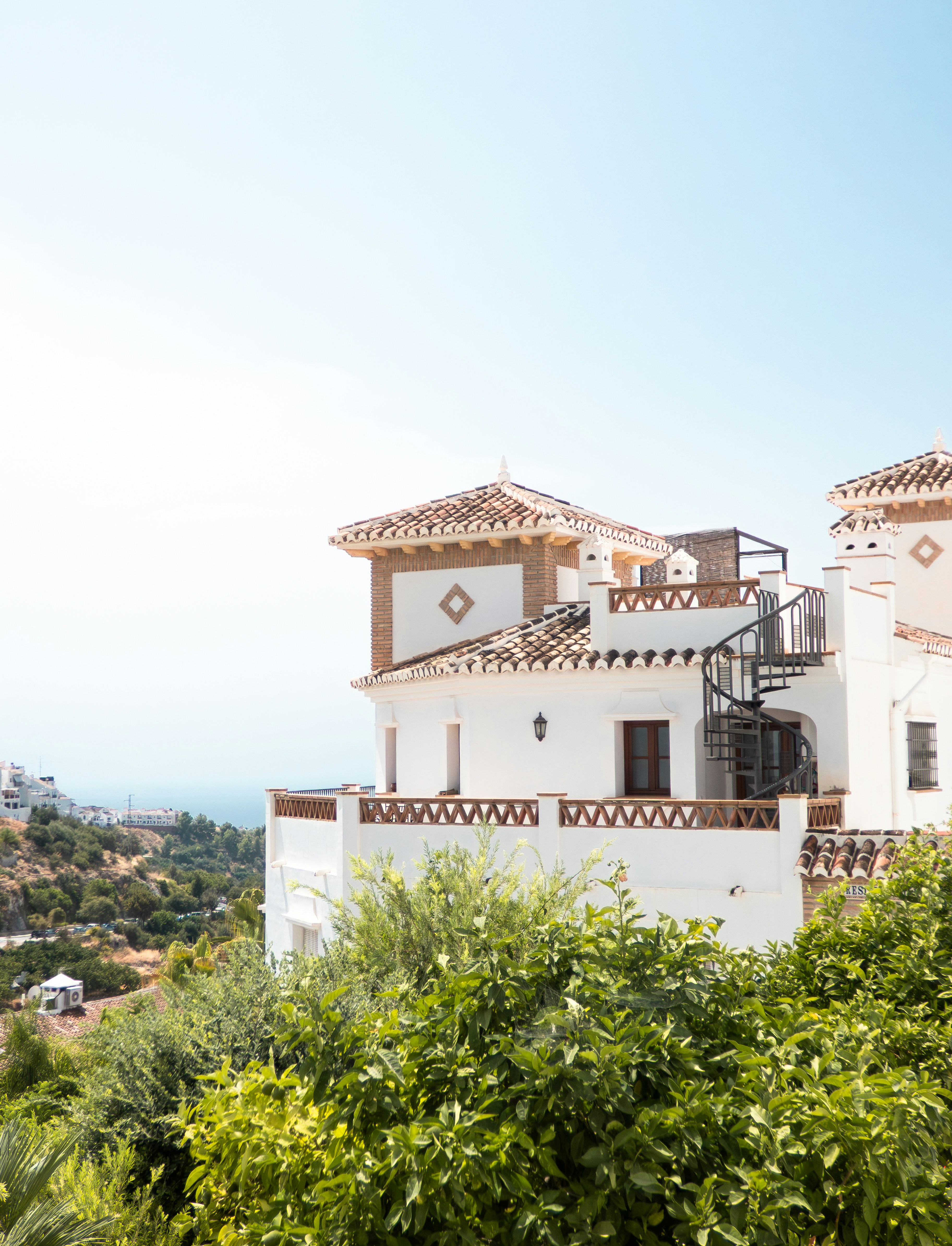White Villa Overlooking a Terraced Landscape under a Clear Sky