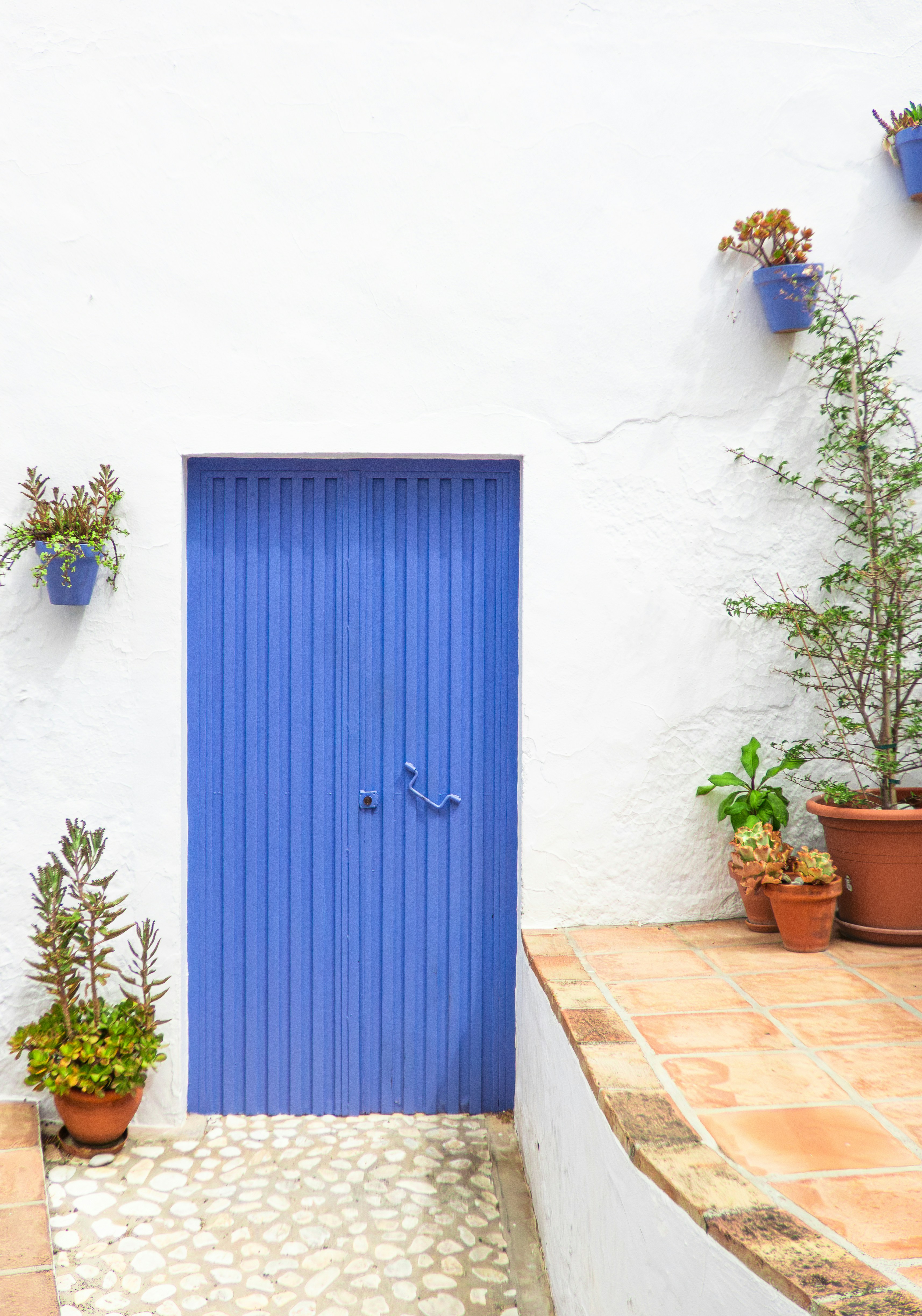 Azure Doorway in a Sunlit Courtyard