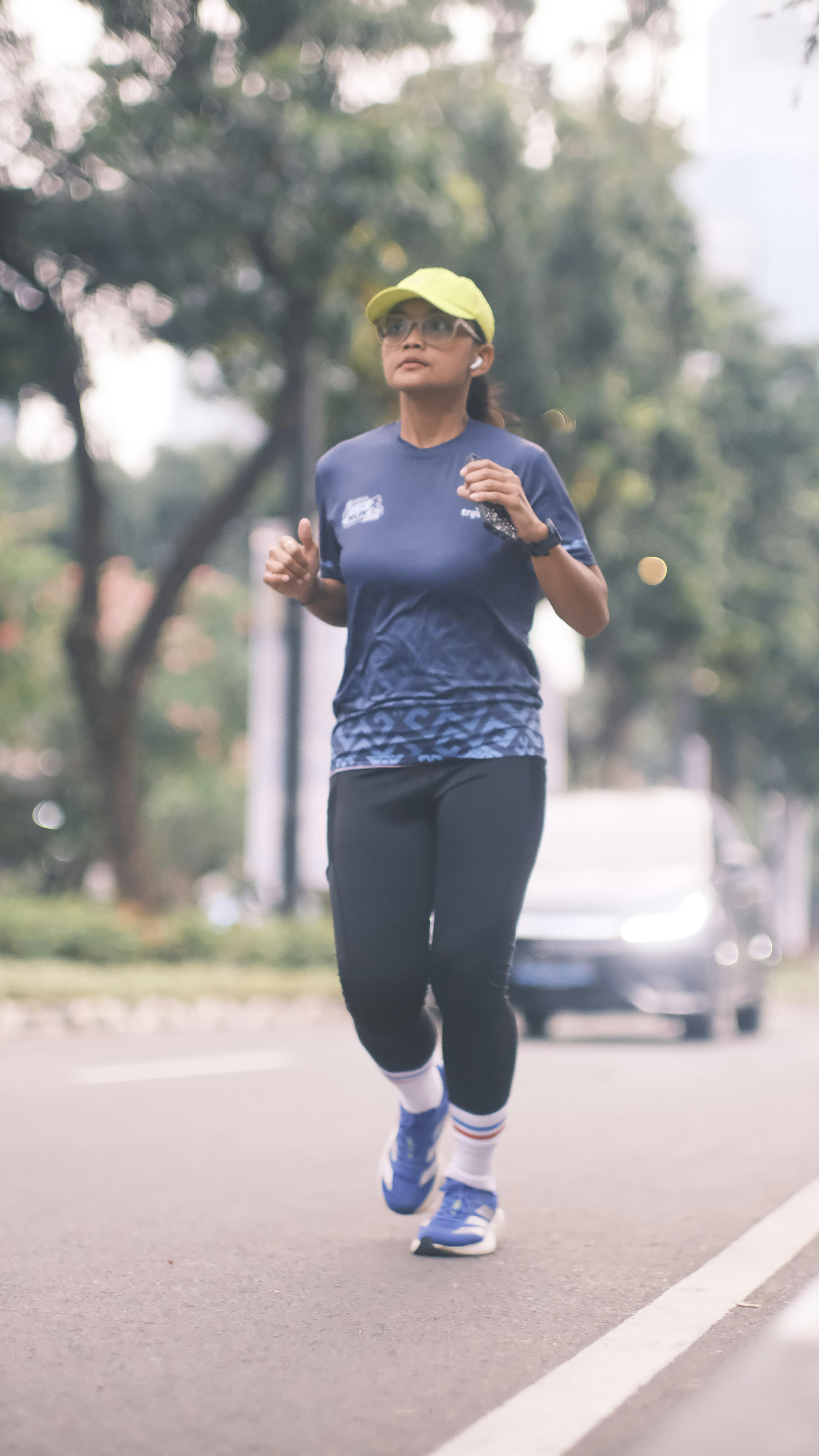Runner in Neon Cap: Focused Pace on a City Street