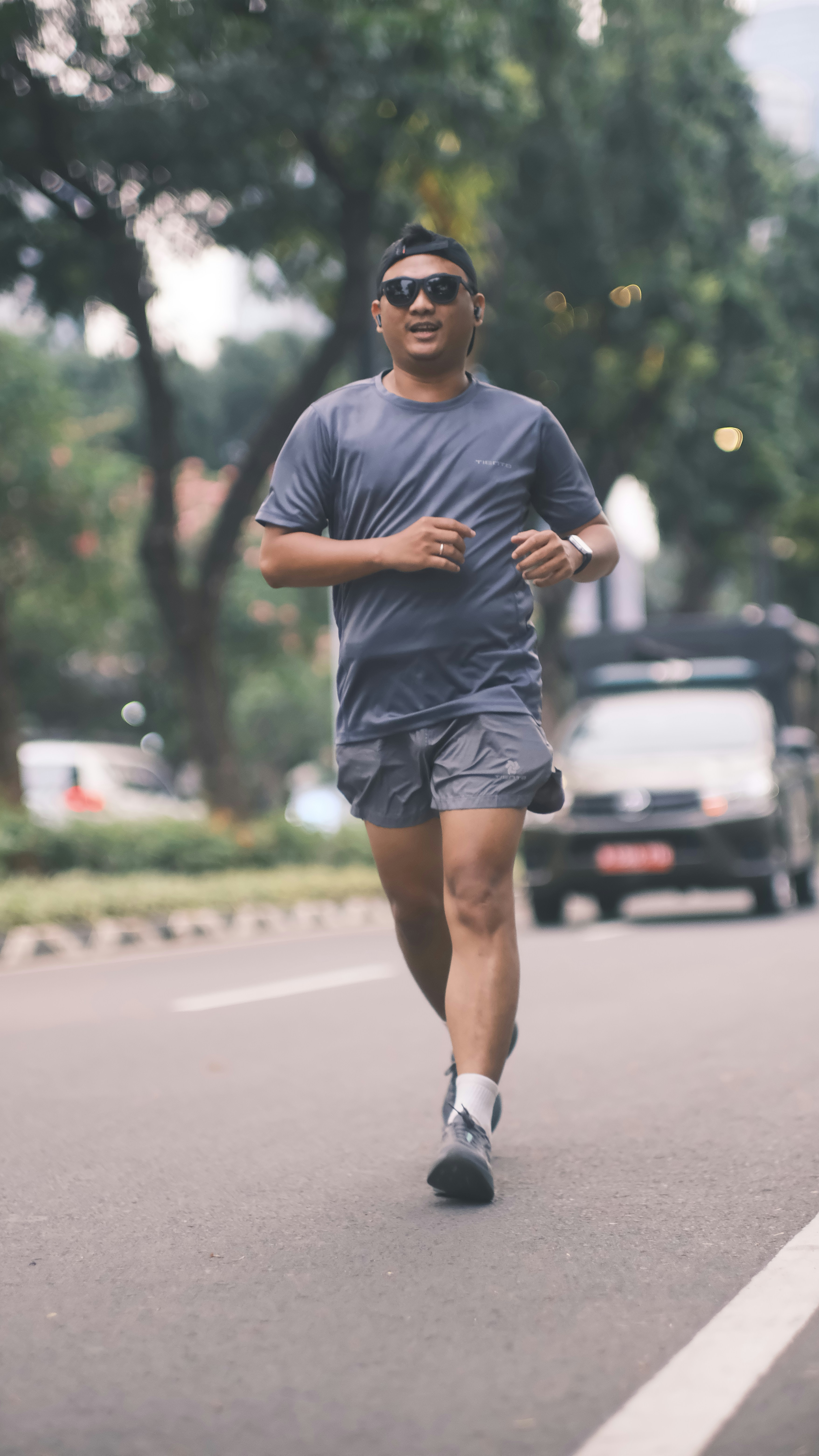 Midstride Momentum: A Jogger Reaches Forward on a Calm City Street