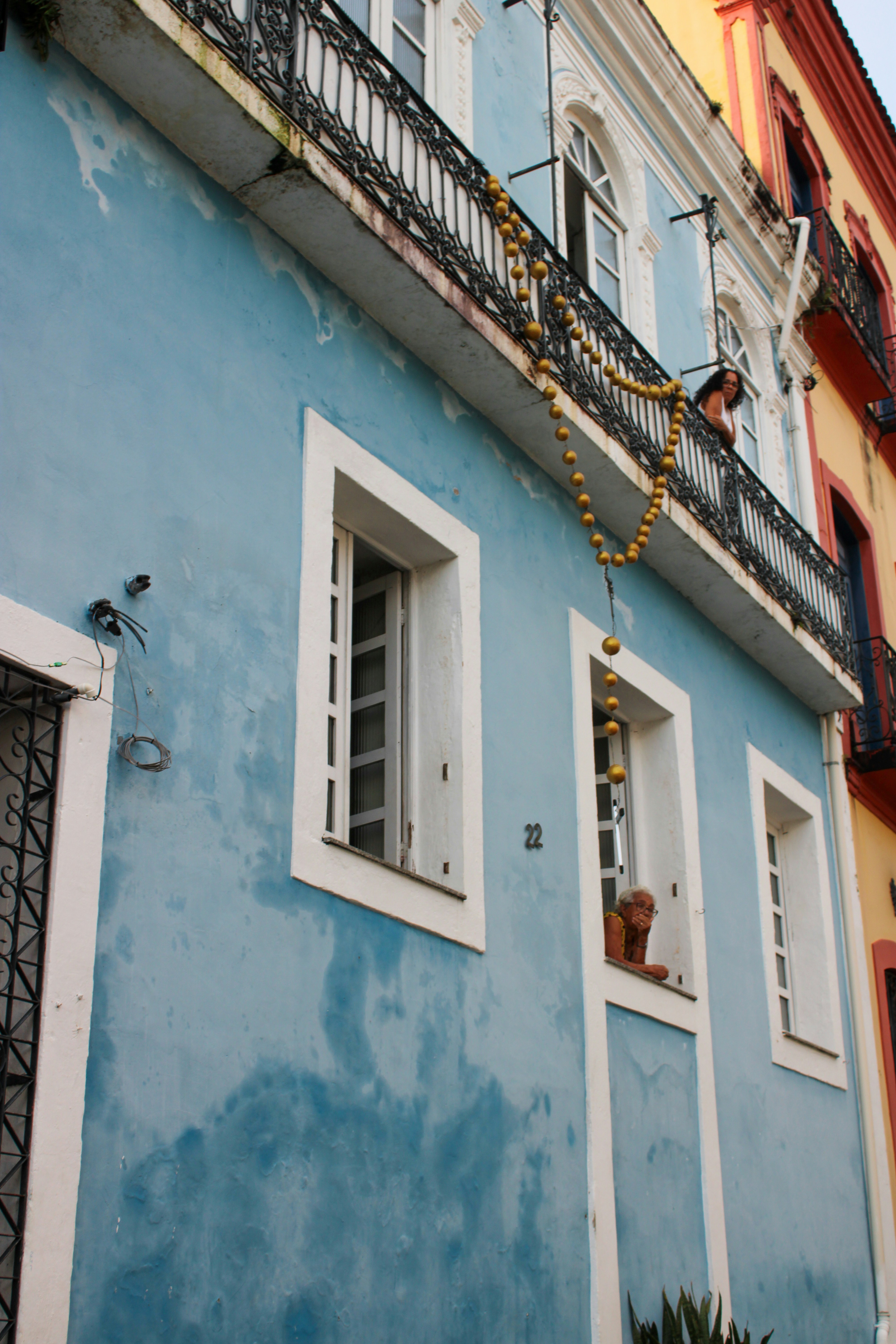 Colorful Facade Carousel: A Balcony and a Curious Gaze