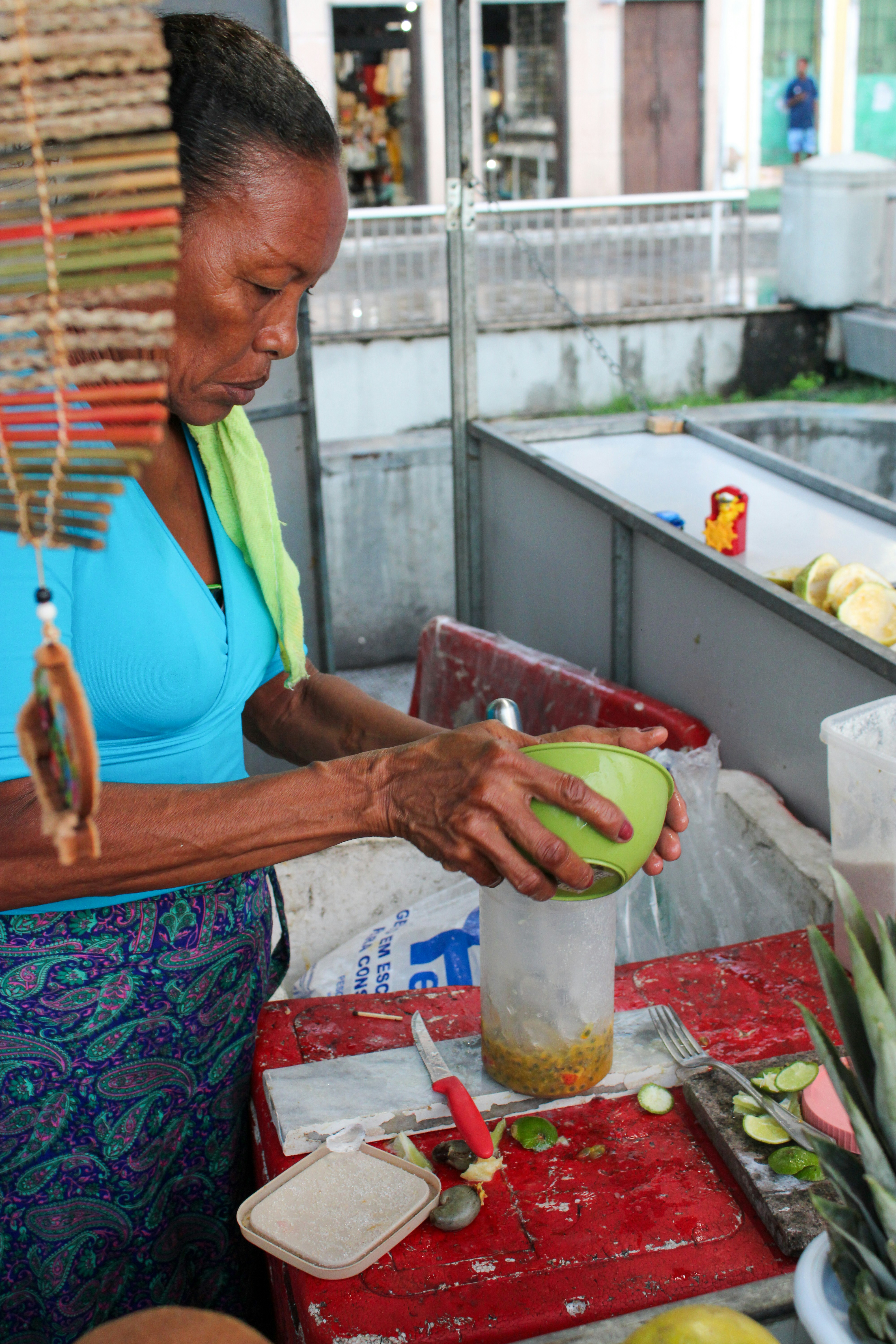 A Woman Preps Fresh Produce at a Street Market Sink