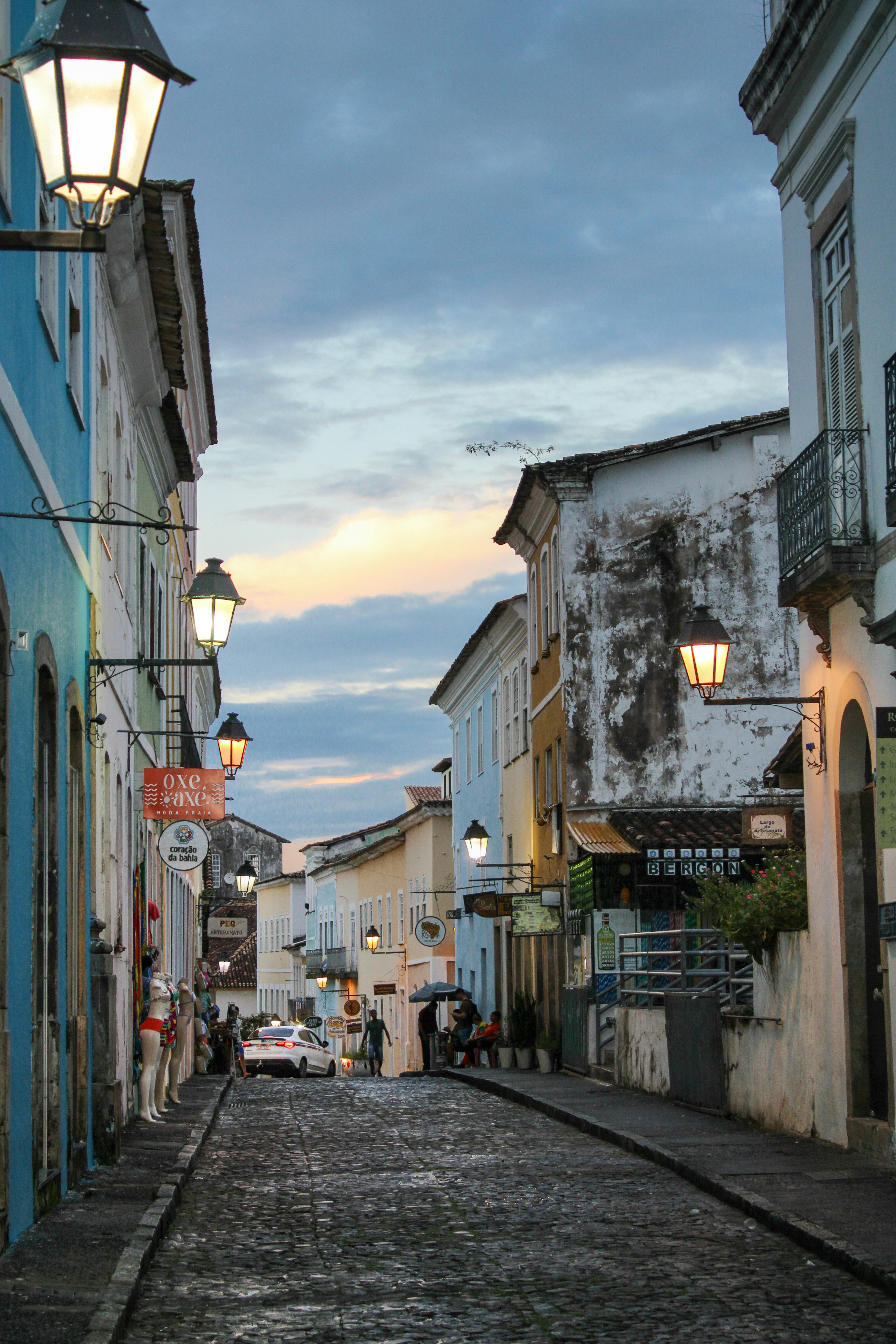 Evening Lanterns Over a Cobblestone Street in Colourful Town
