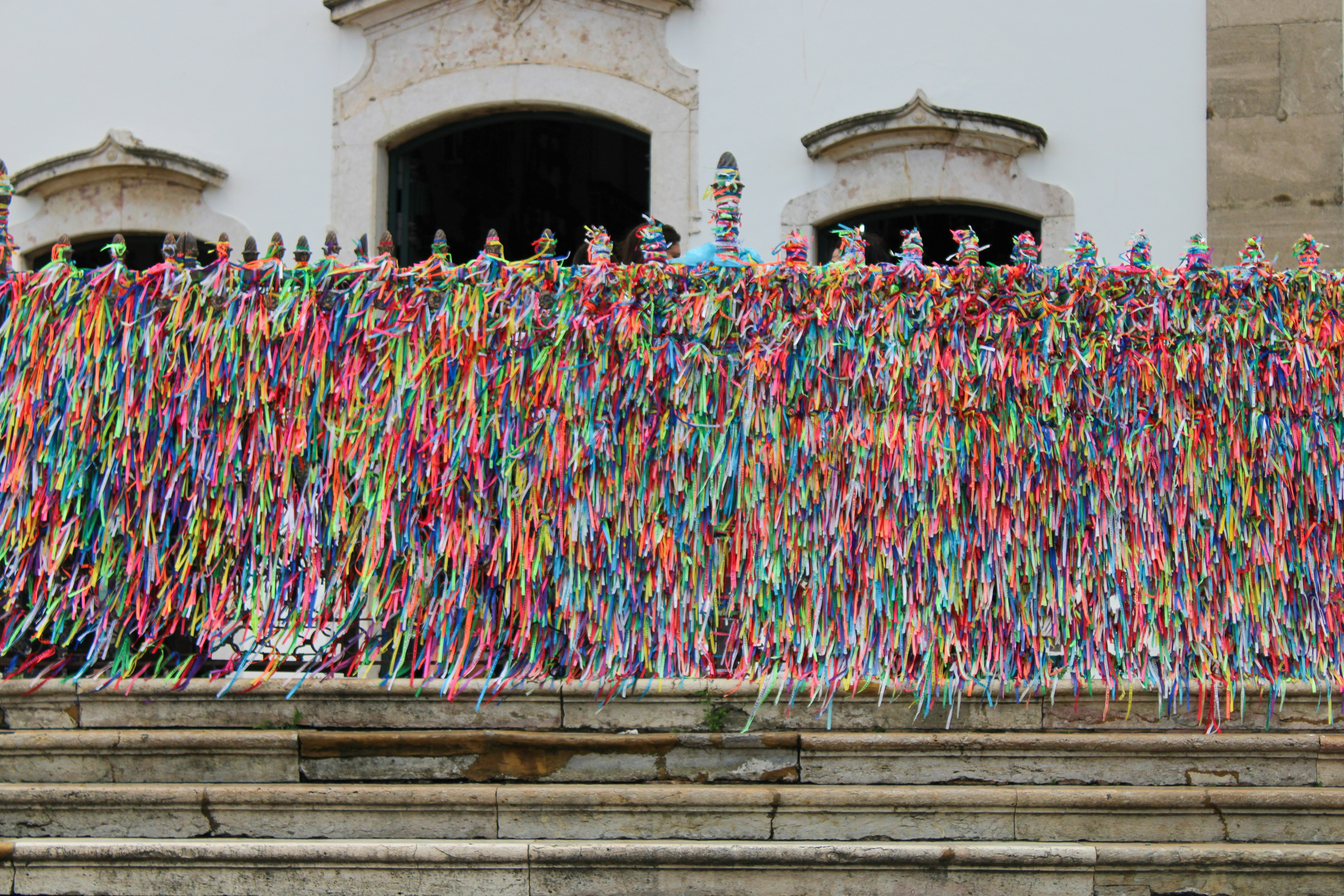 Colorful threads over stone steps at a historic balcony