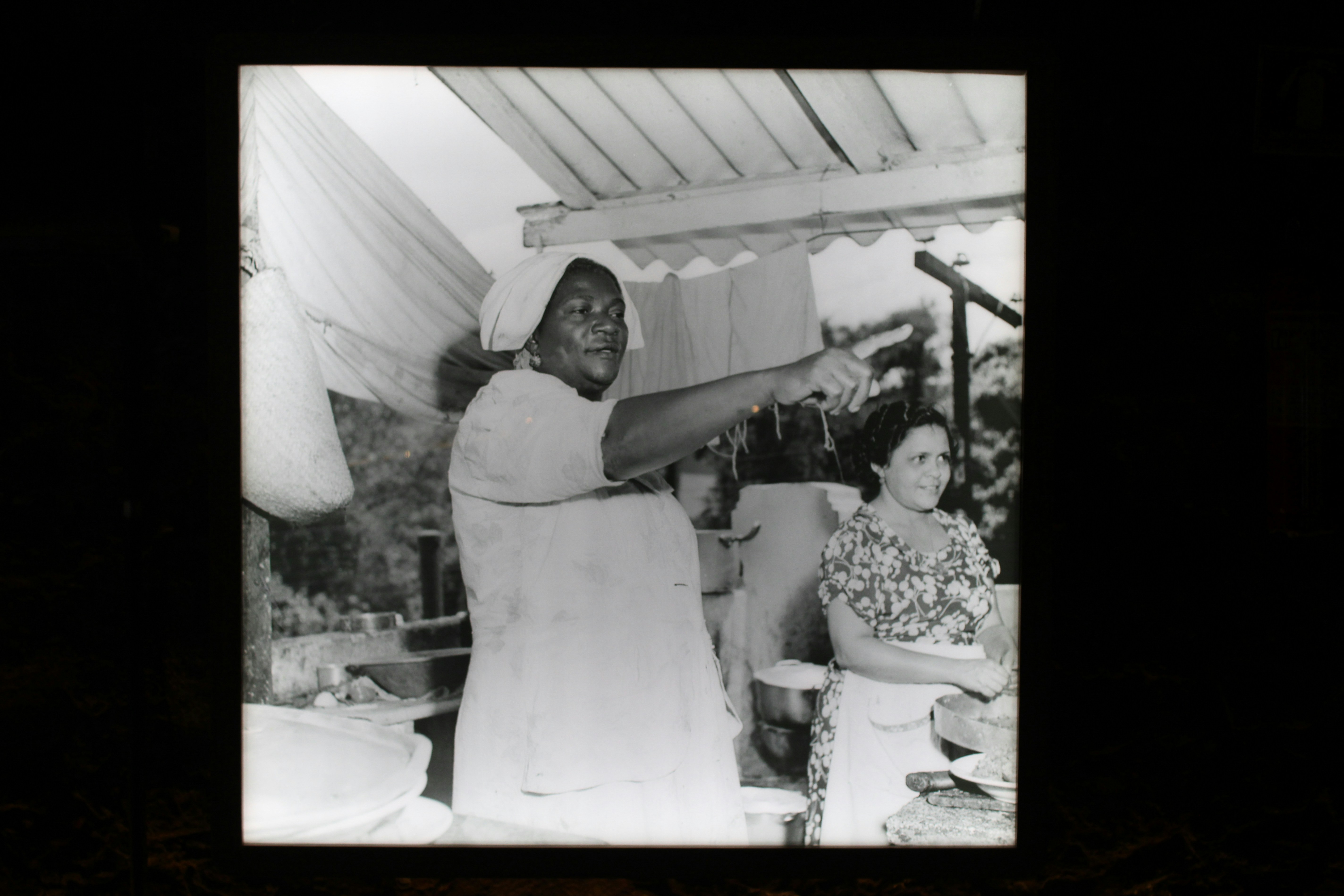 Serving Moments: A Black-and-White Kitchen Scene with a Charismatic Host