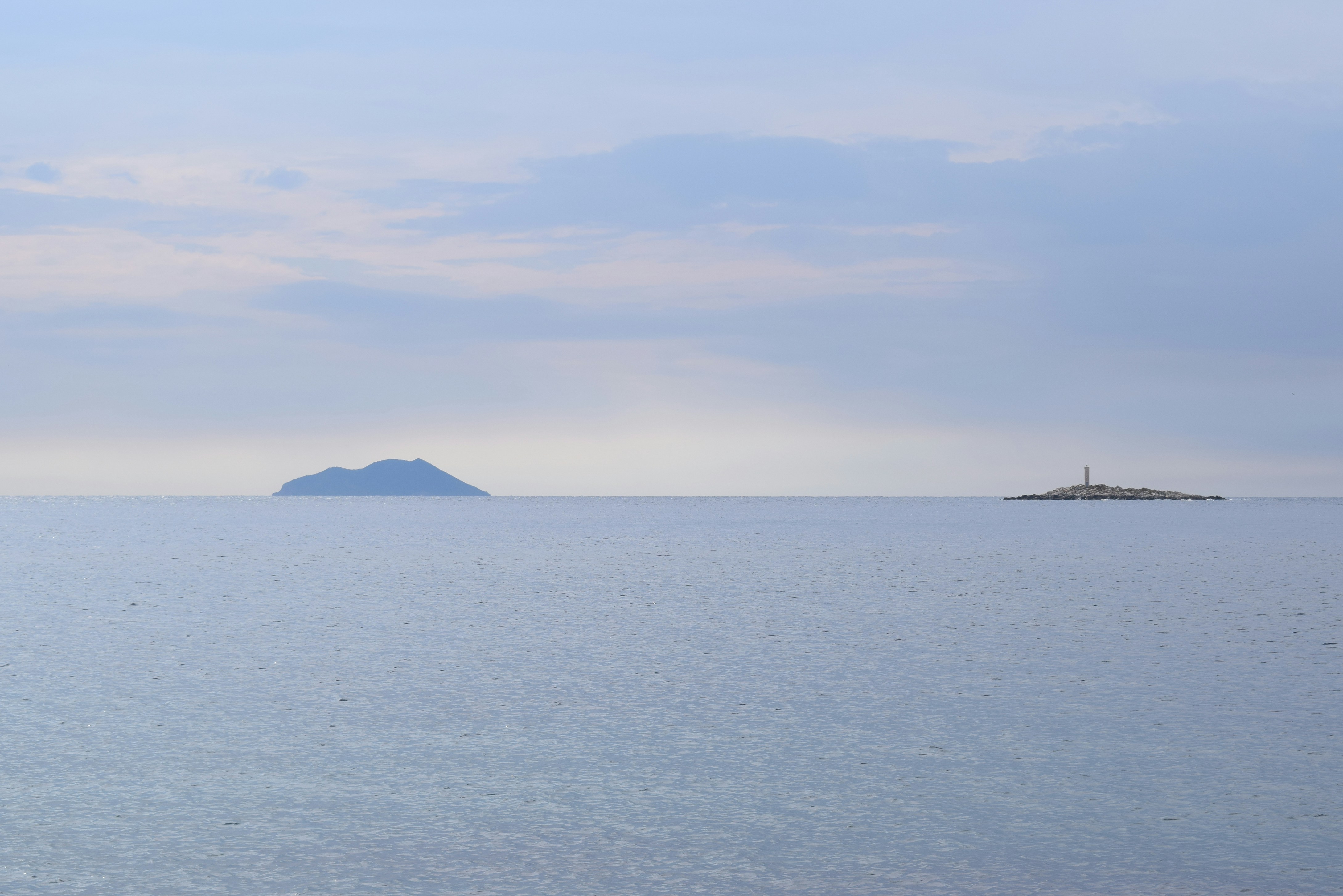 Horizon Sentinel: A Misty Sea with a Distant Island