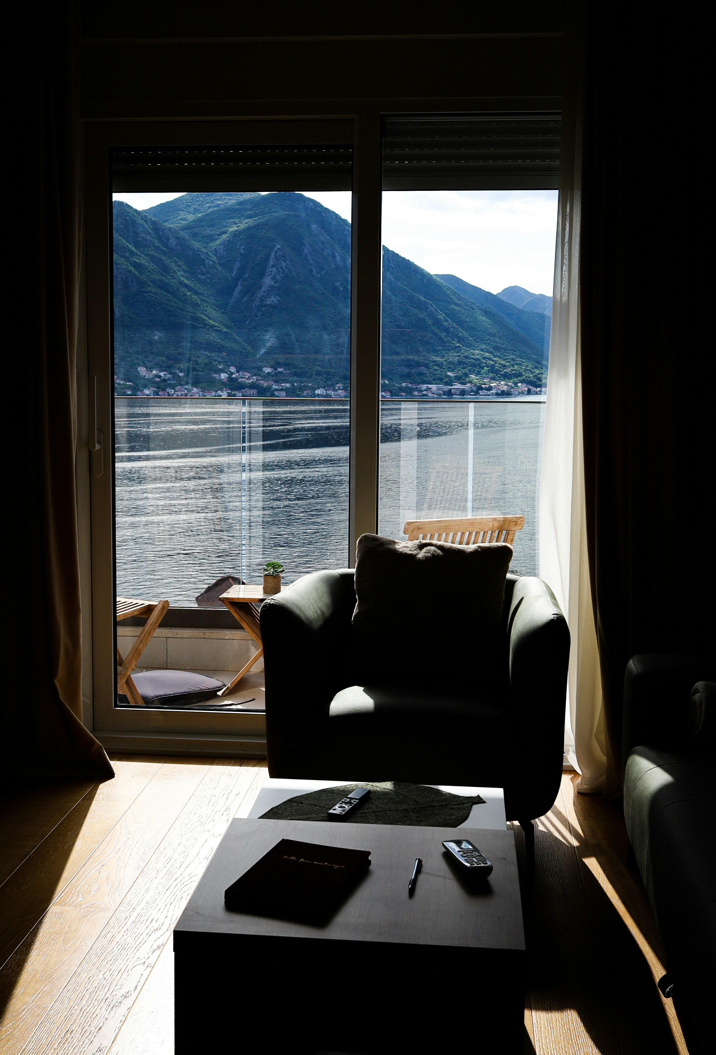 Sunlit View Through a Lounge: Mountain Lake Balcony