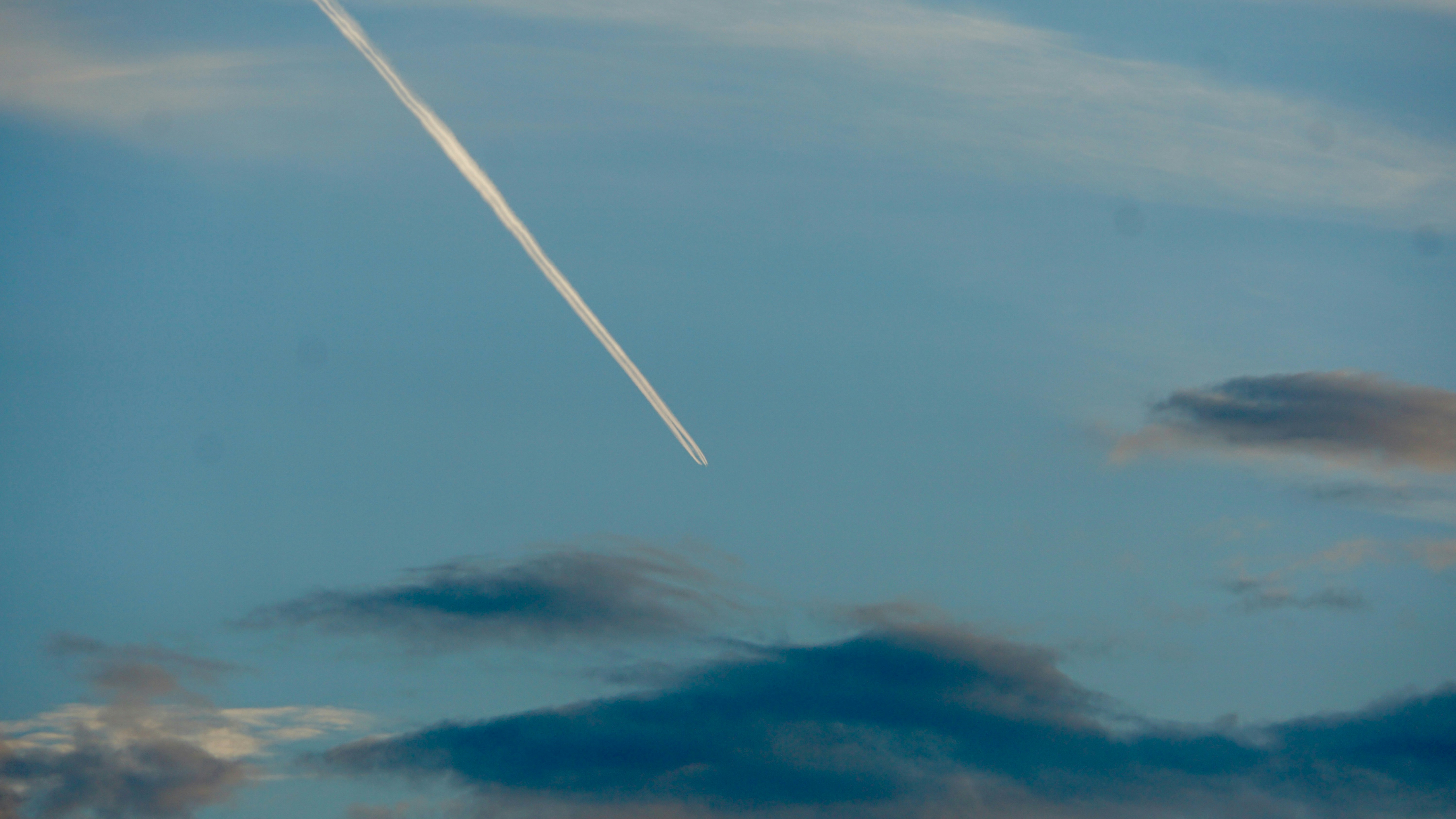 Contrail Arc Across a Serene Sky