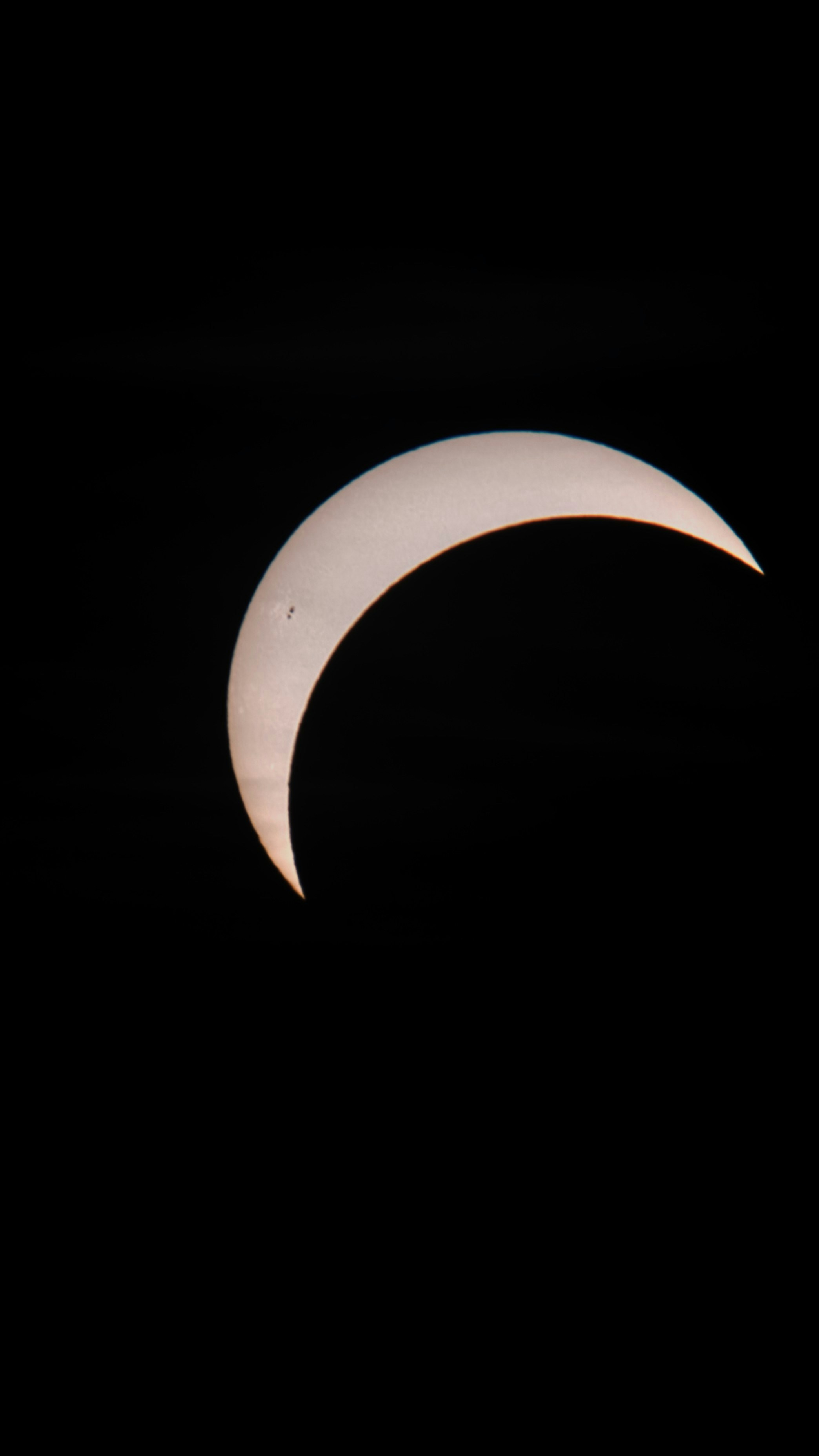 Partial Eclipse: The Crescent Breaks Through a Night Sky
