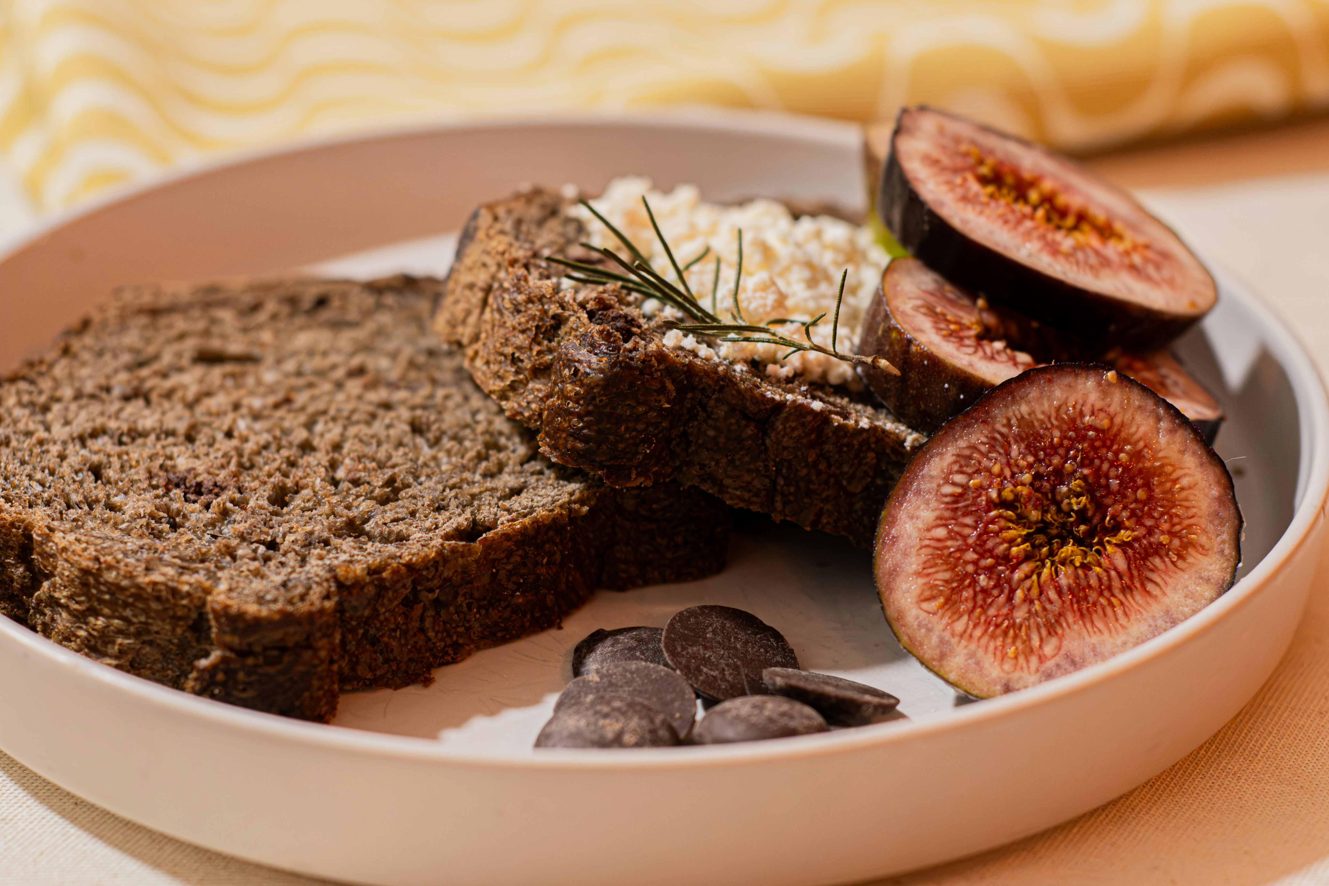 Heritage loaf with figs: a rustic plate with rosemary garnish