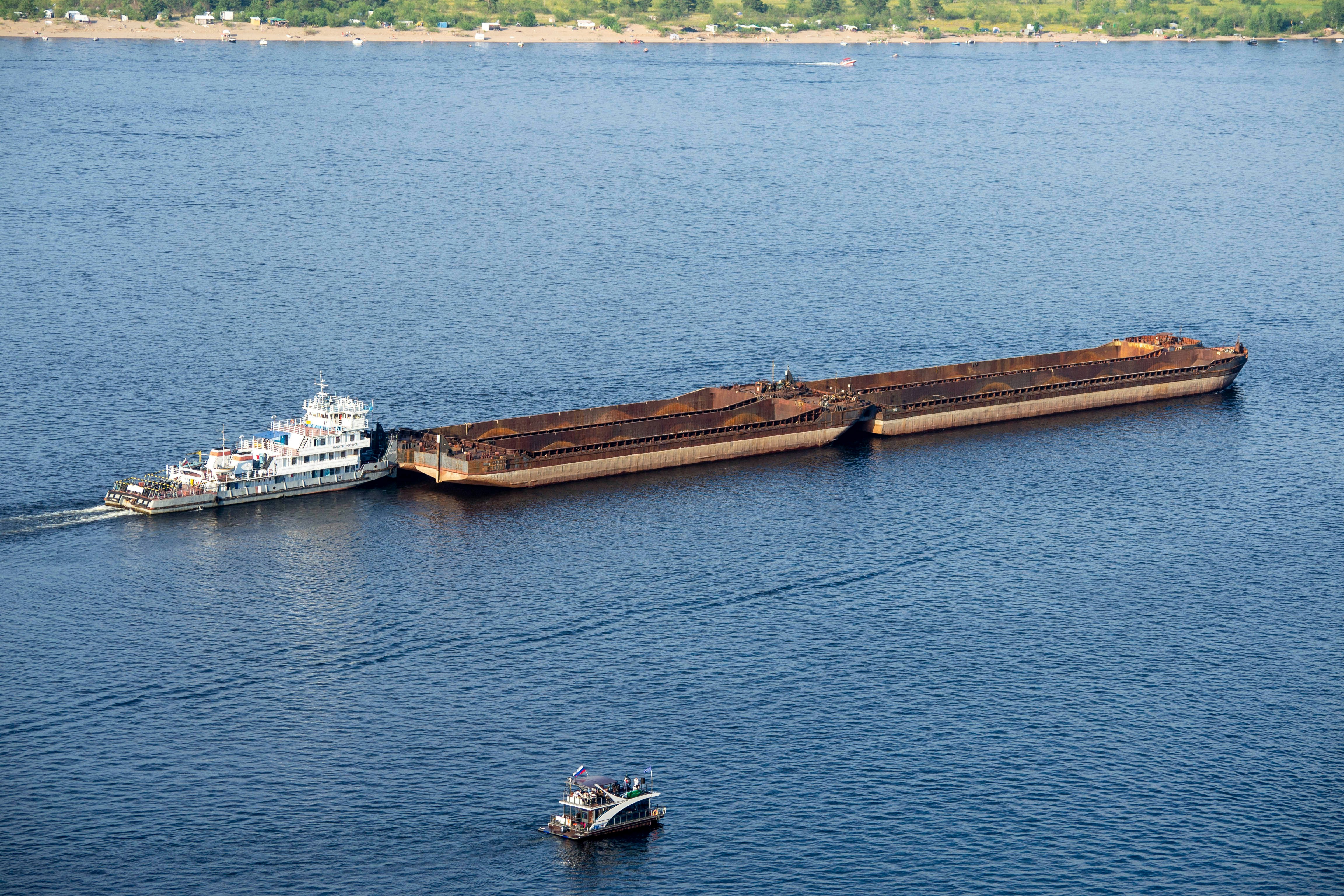 Rusting Railbarge Drifts Across Open Water