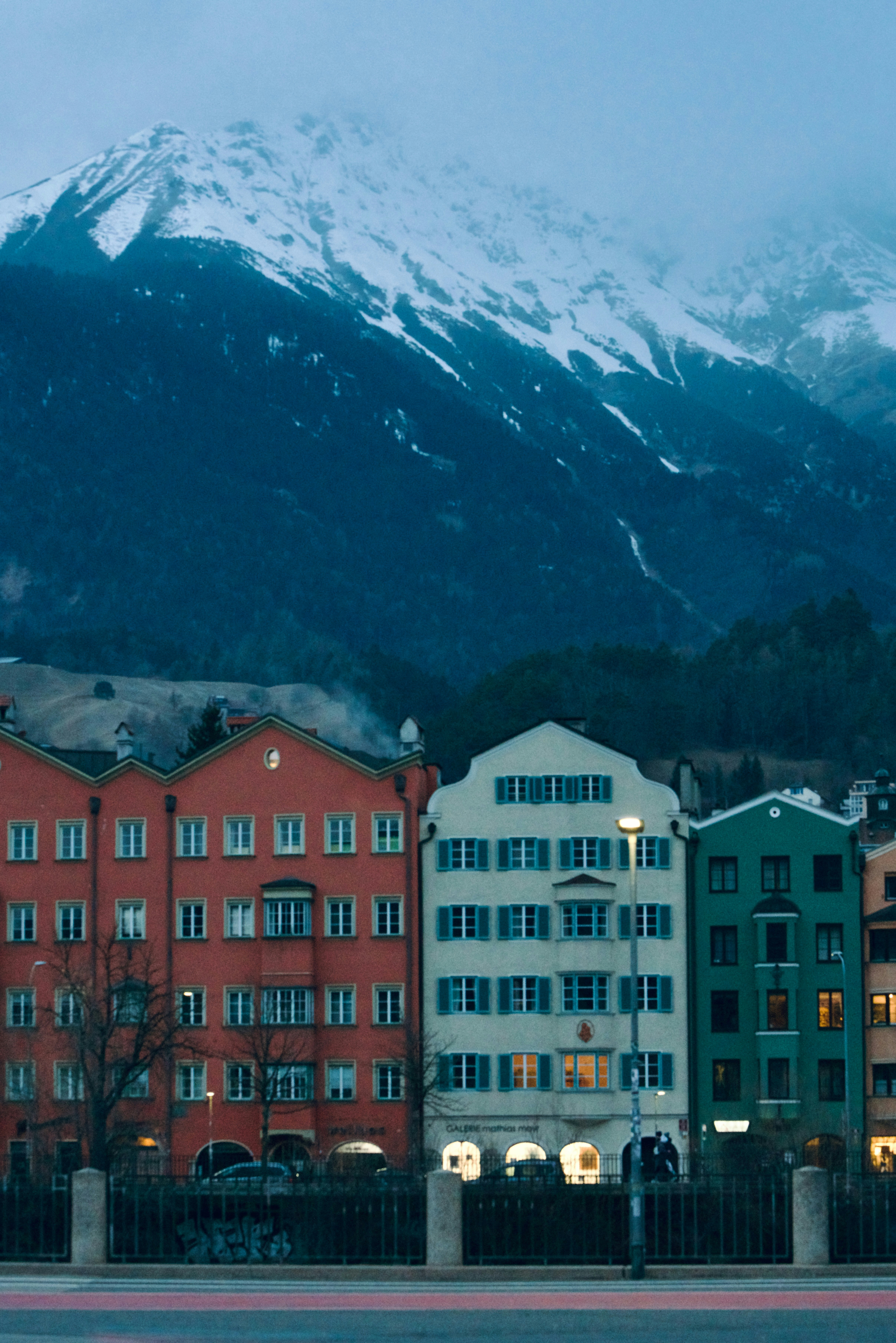 Colorful Alpine Facades Against a Snowy Ridge