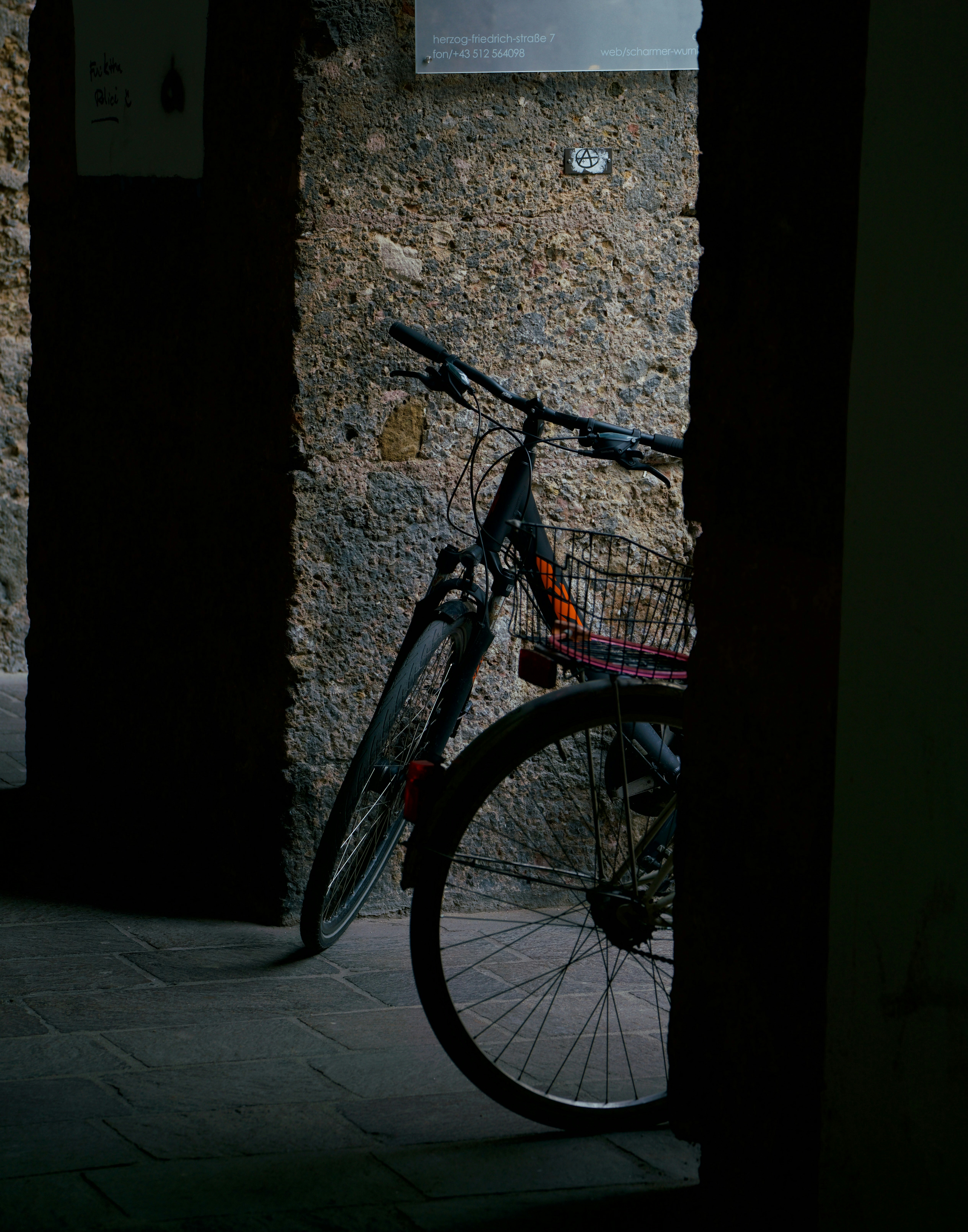 Shadowed Bicycle in a Narrow Archway