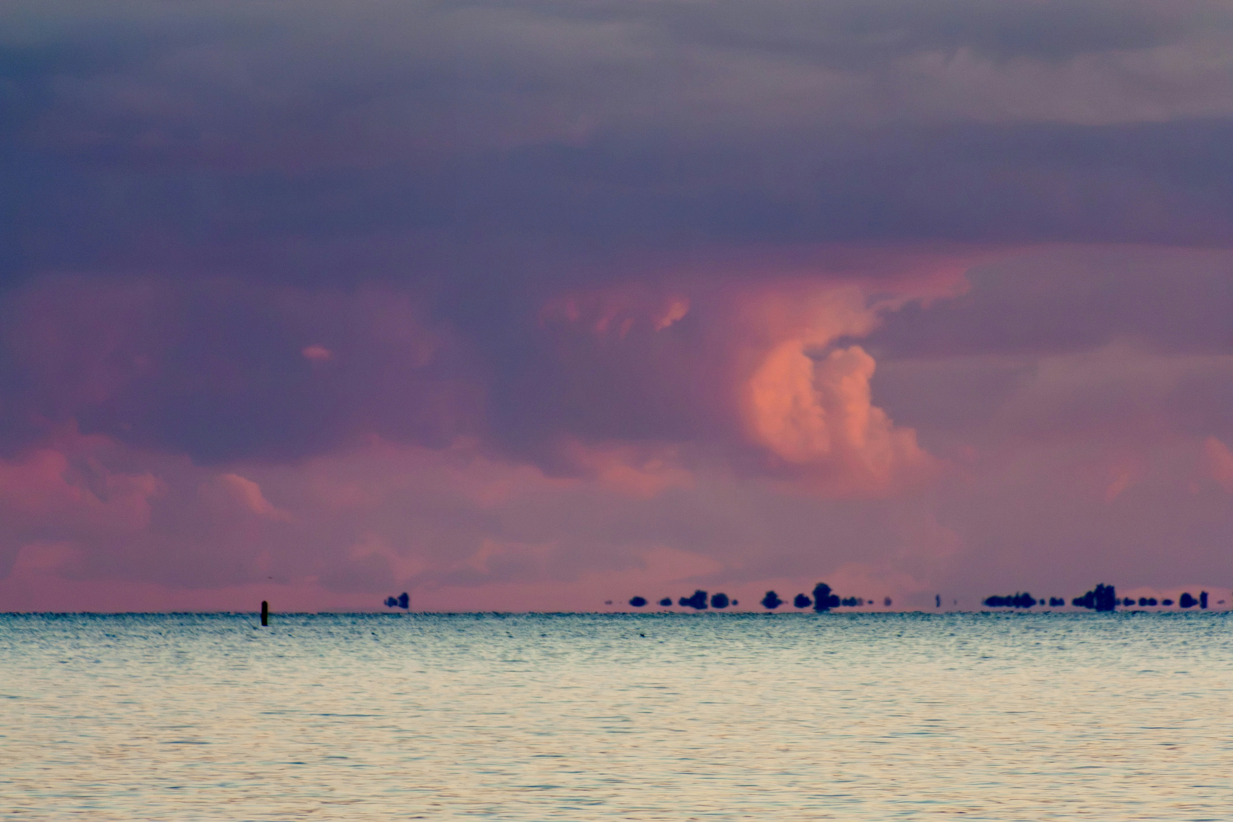 Horizon at Dusk: Gentle Sea and Looming Storm