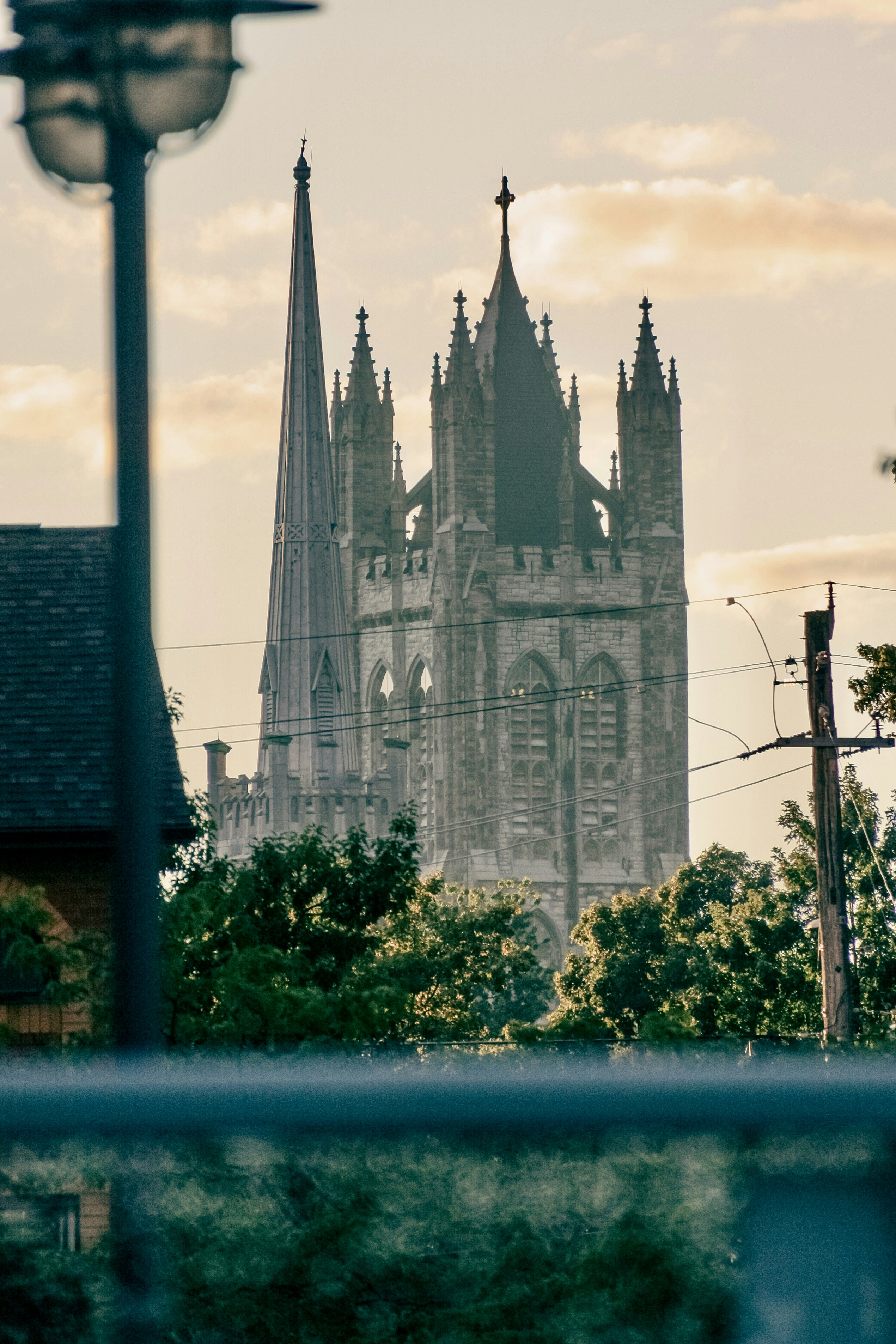 Gothic Spires Beyond the Rail: Urban Quiet in Evening Light
