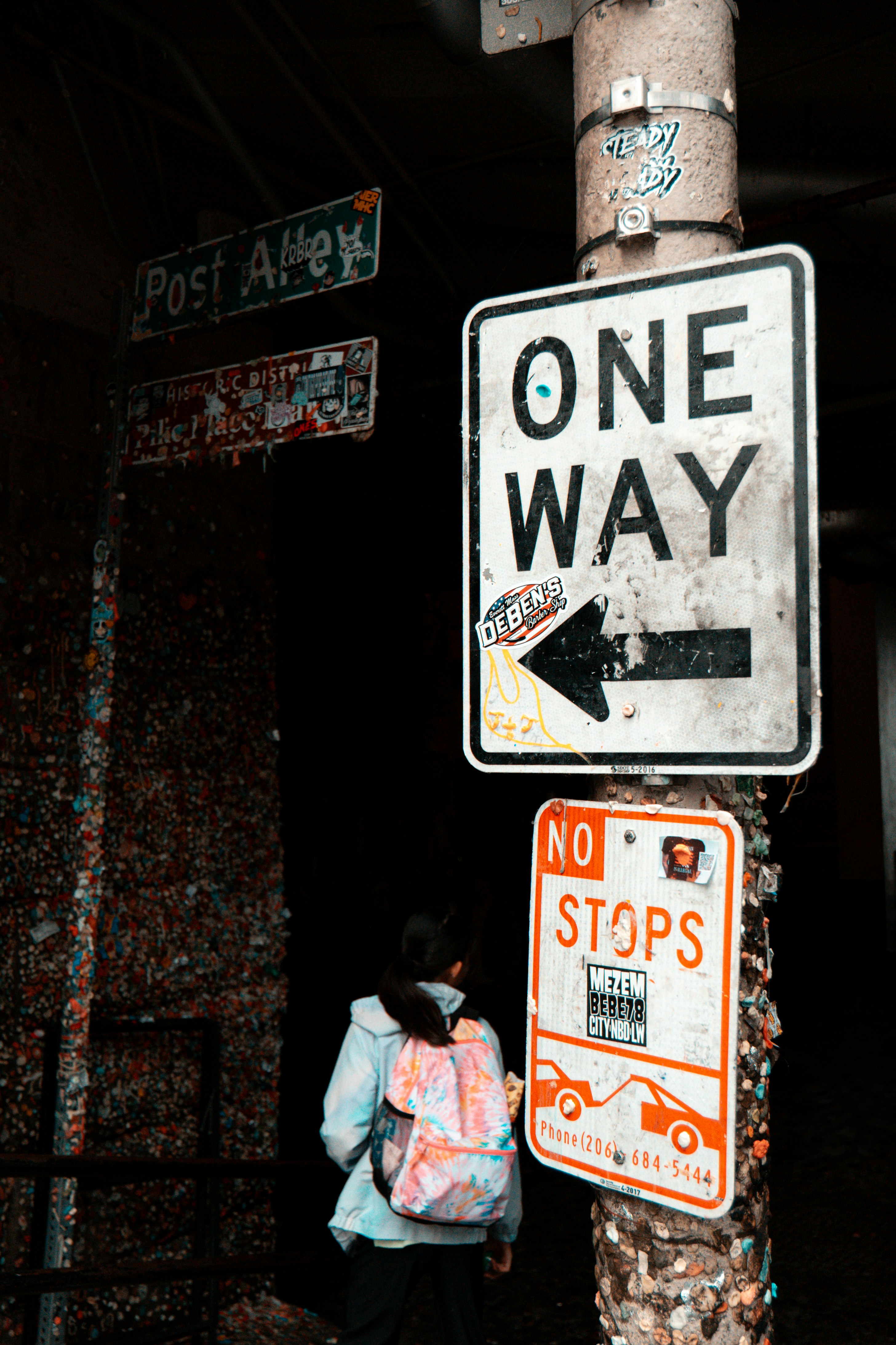 One Way to the Unknown: A Quiet Alley Entrance Framed by Weathered Signs