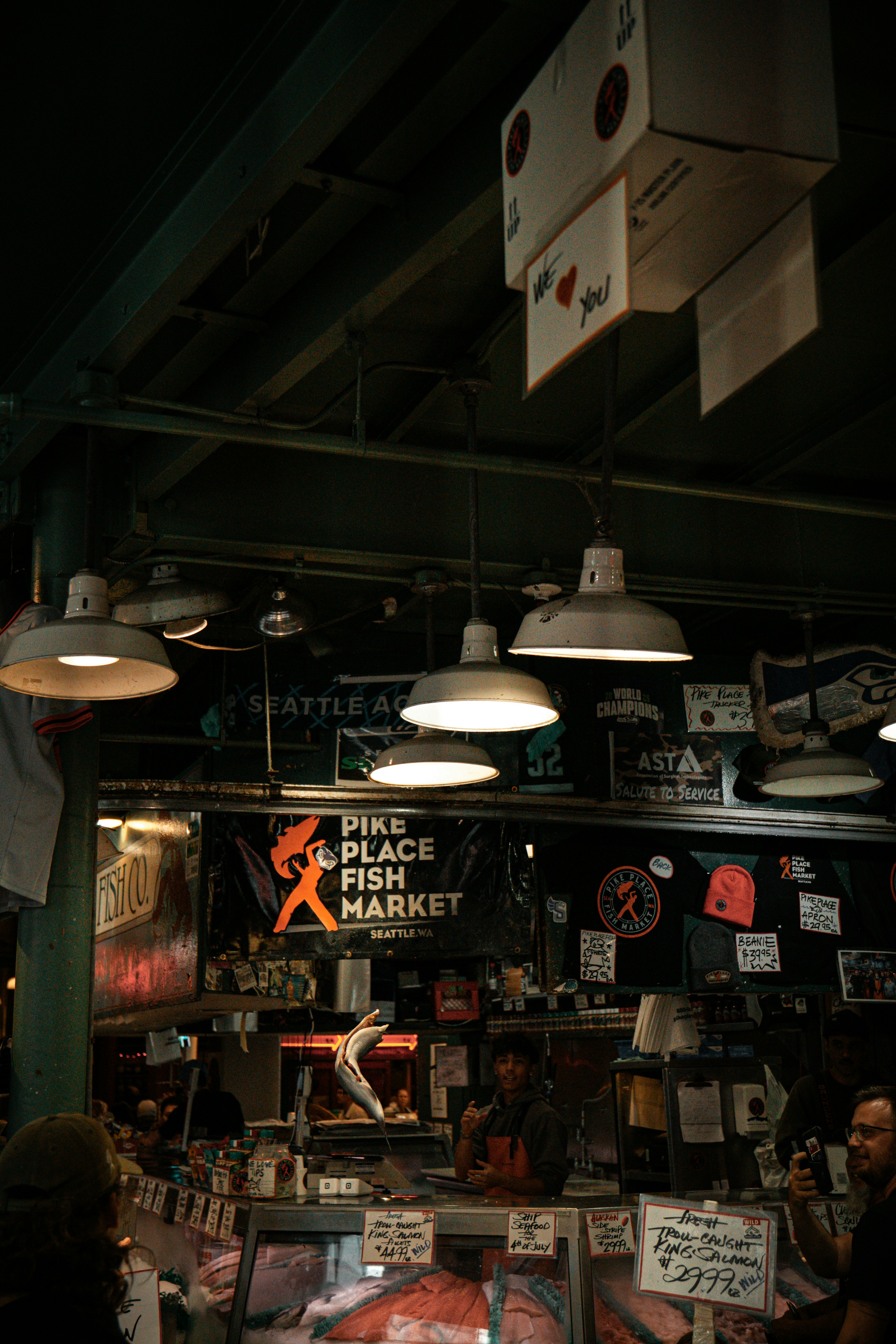 Under the Neon Banners: A Market Portrait in Warm Light