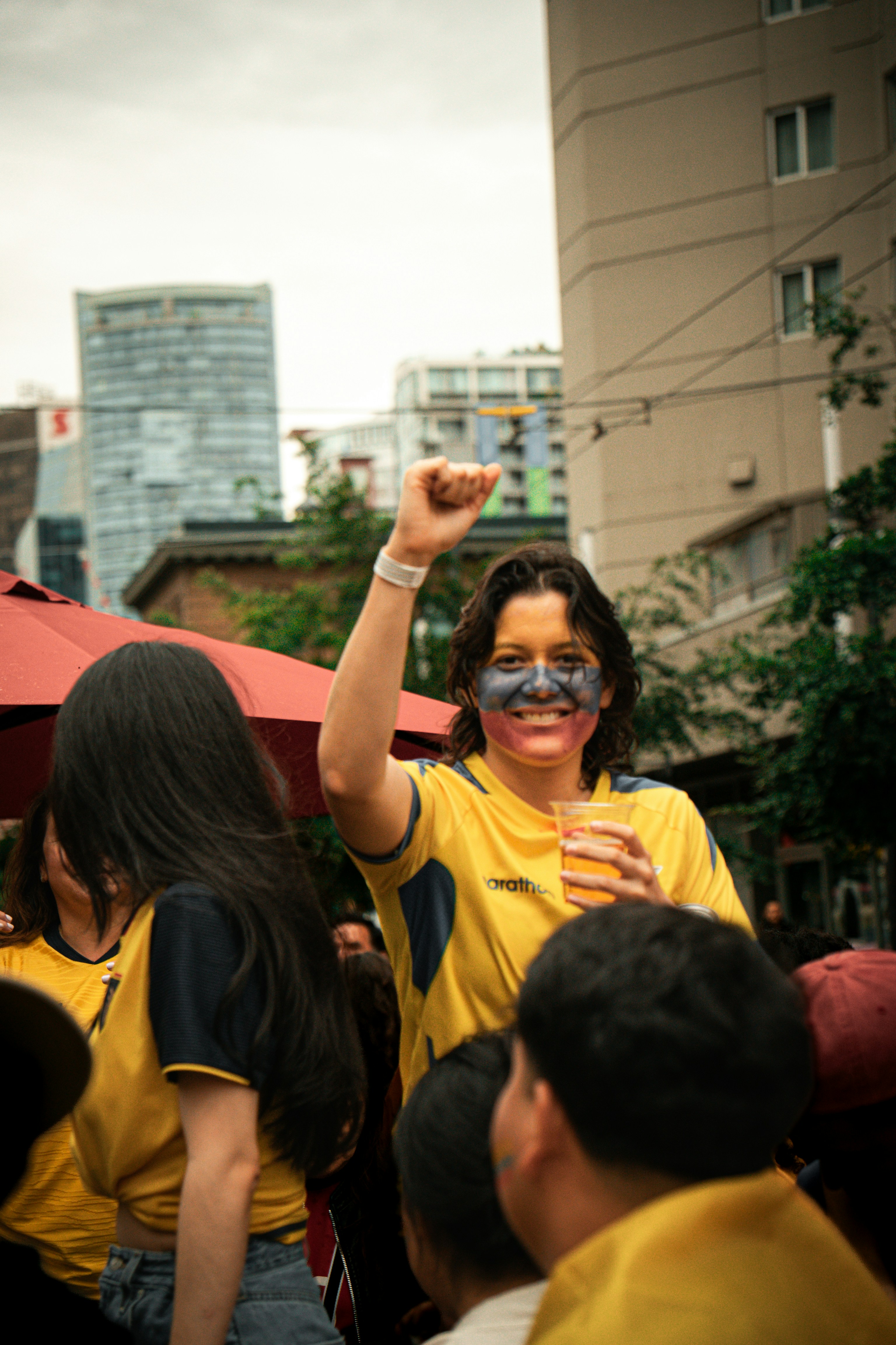 Celebration in Yellow: A Gaze Upward Amid urban crowds