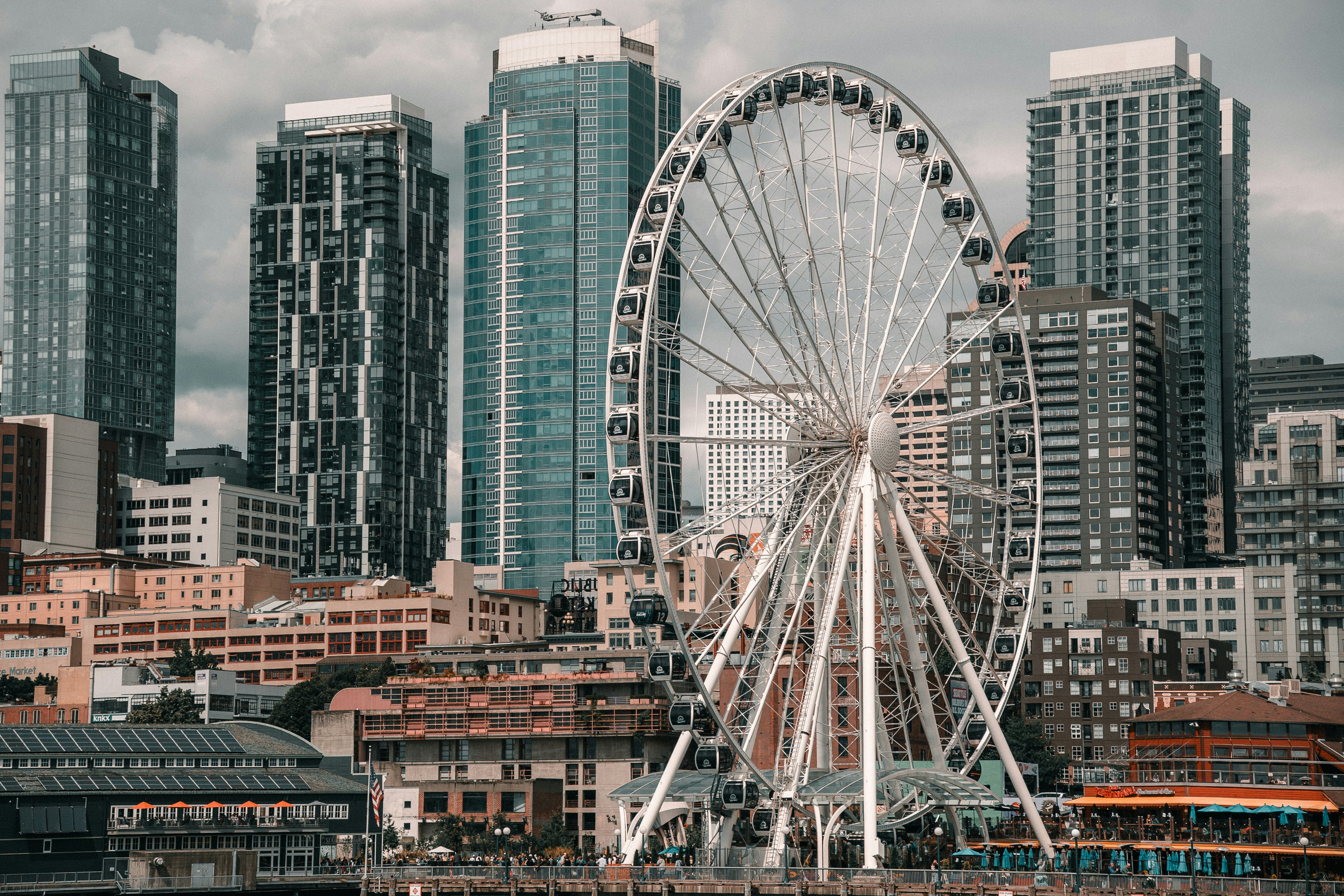 Urban Wheel of Light: A Ferris Wheel Dominates a Modern Harbor Skyline
