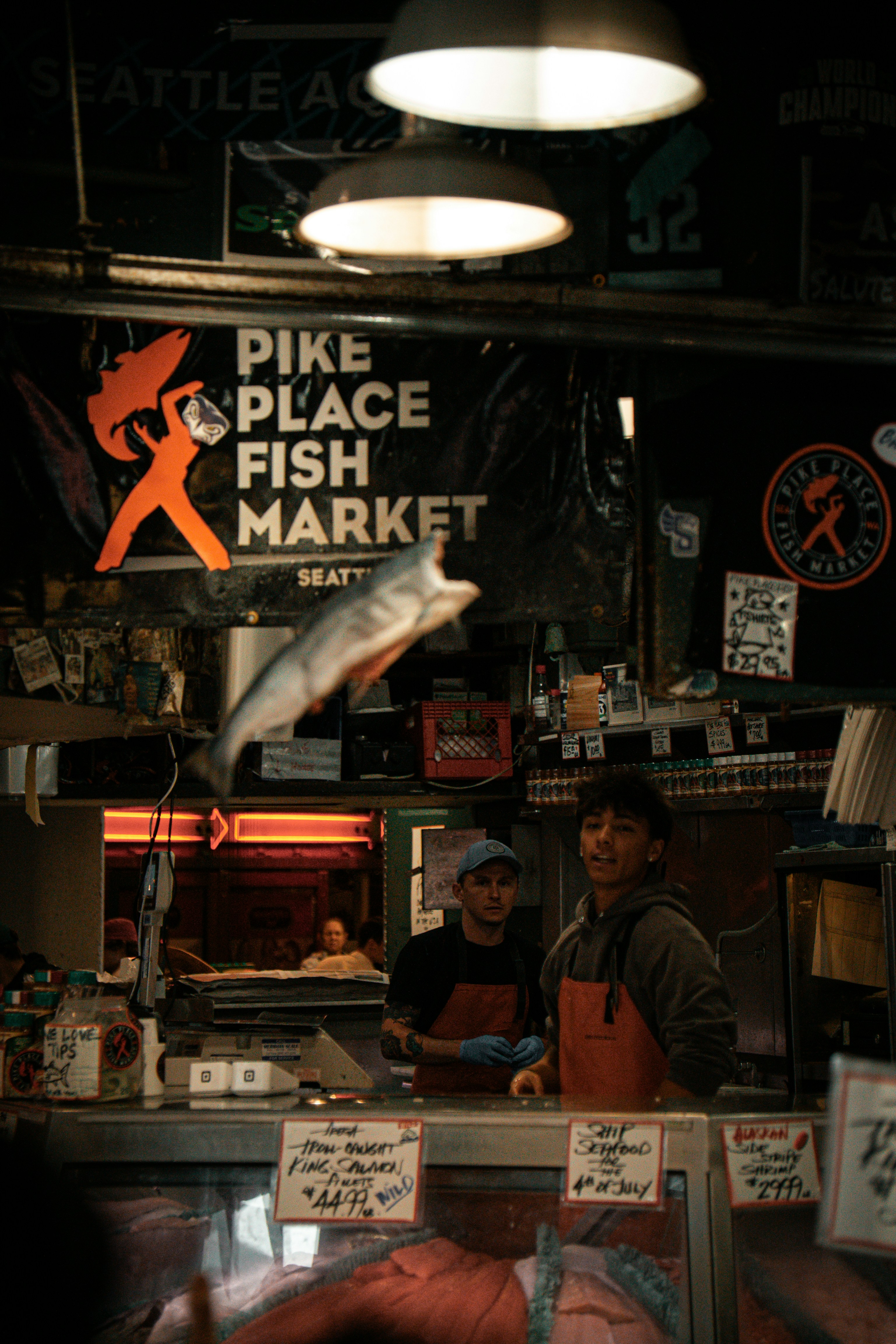 Fish Market Clash: A Fishmonger’s Moment Under Neon and Overhead Light