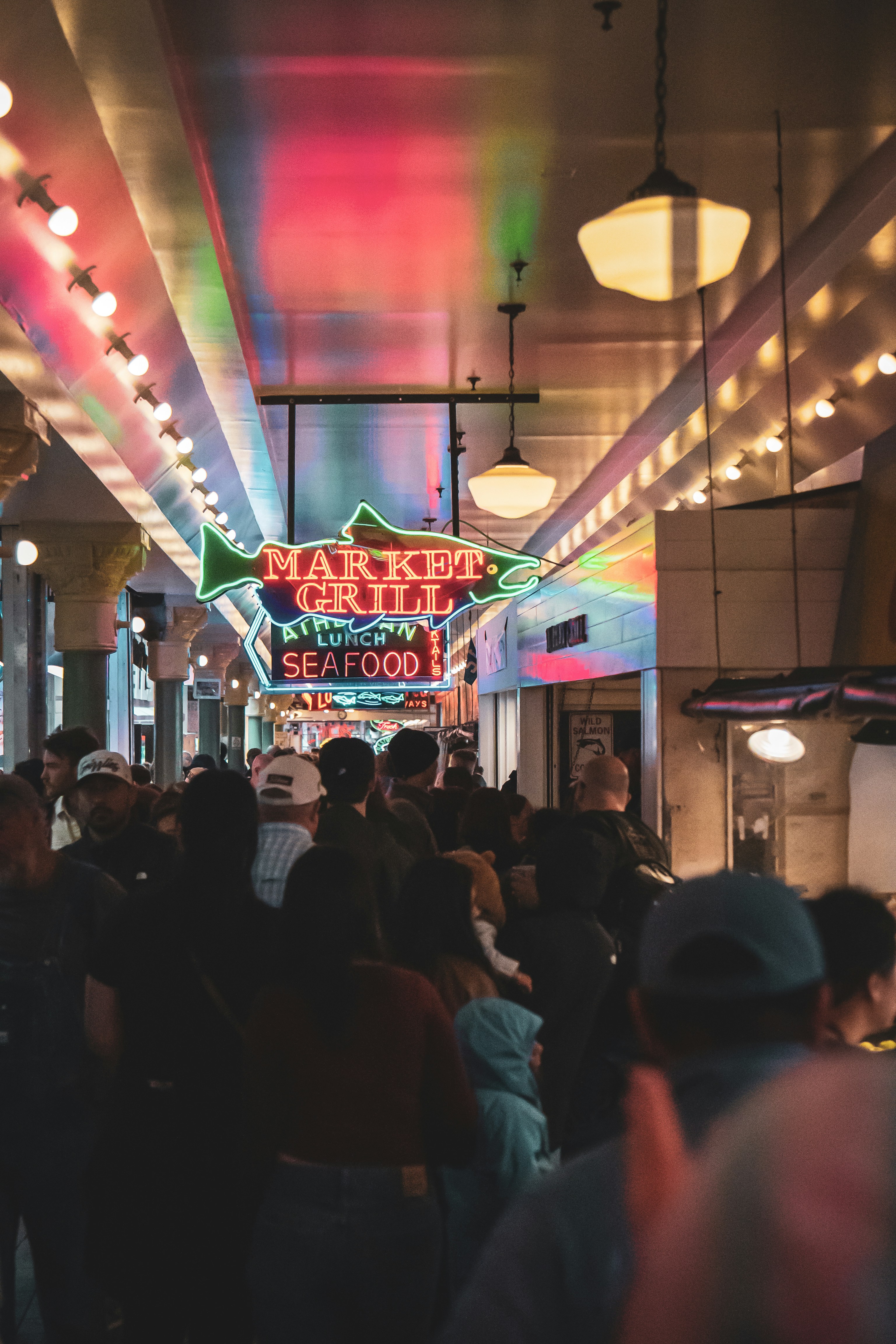 Neon Alley: Crowds Beneath a Market Grill Sign