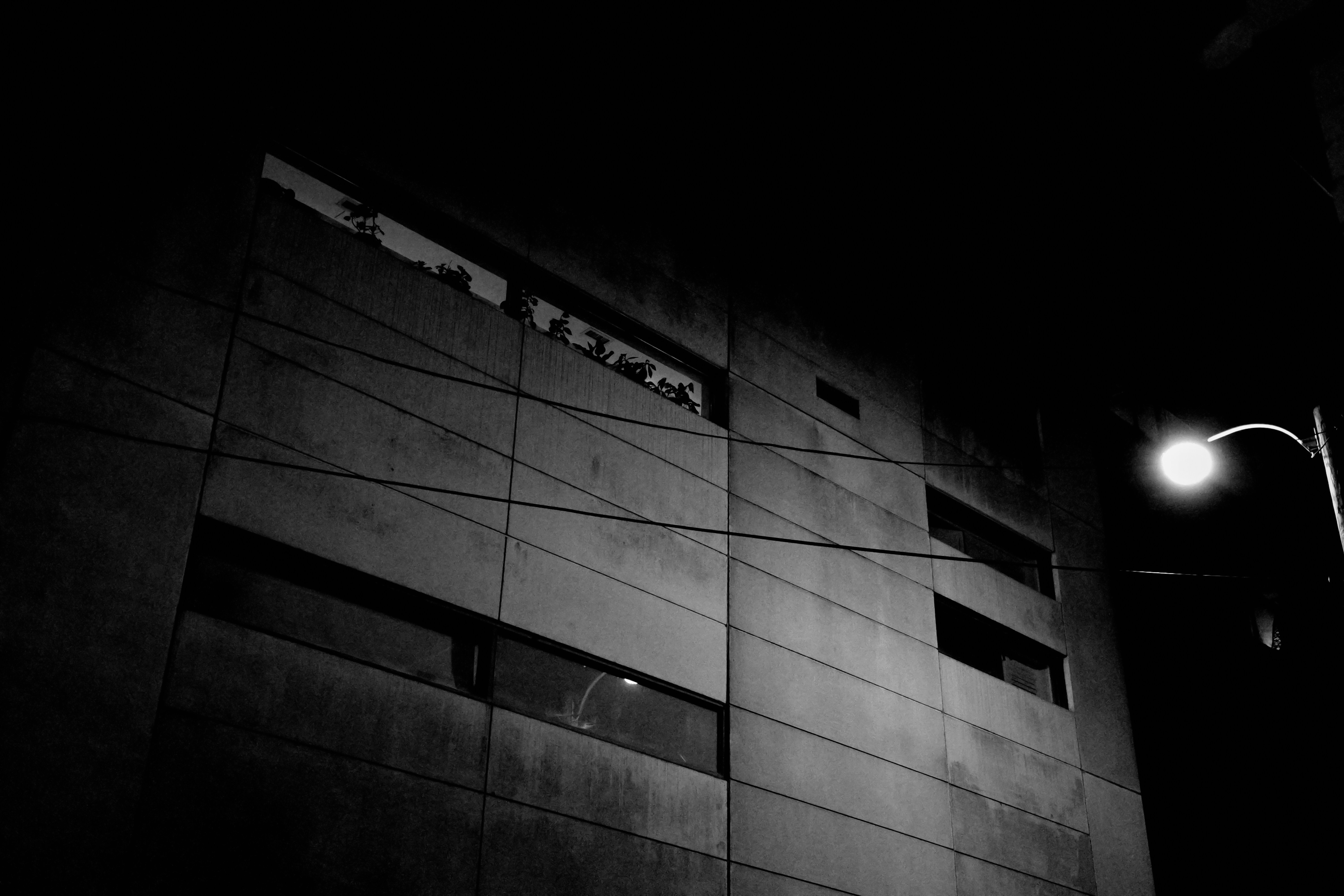 Midnight Facade: Streetlight Illuminates a Quiet Building Edge