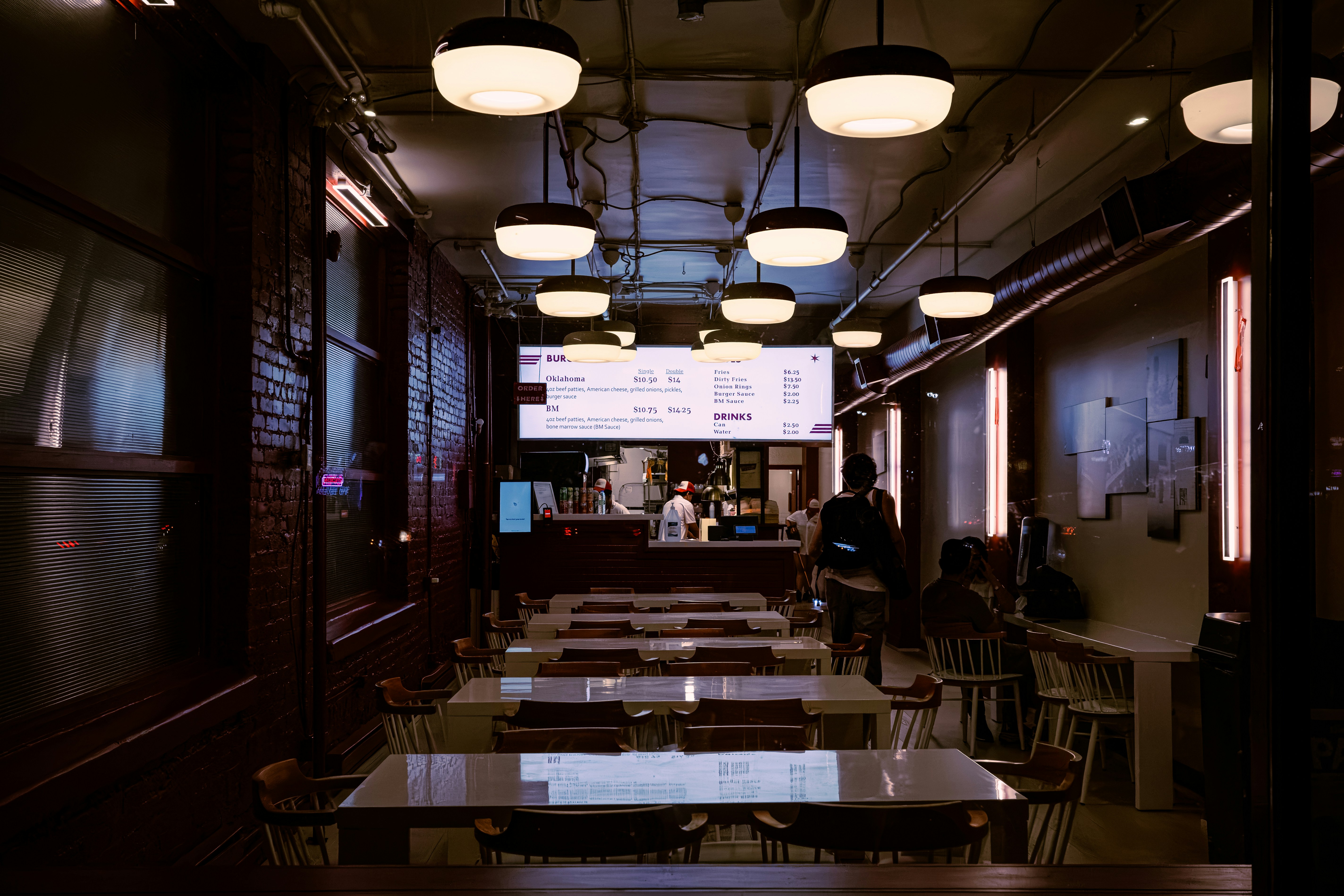 Midday Mirage: Quiet Café Corridor Beneath Soft Neon