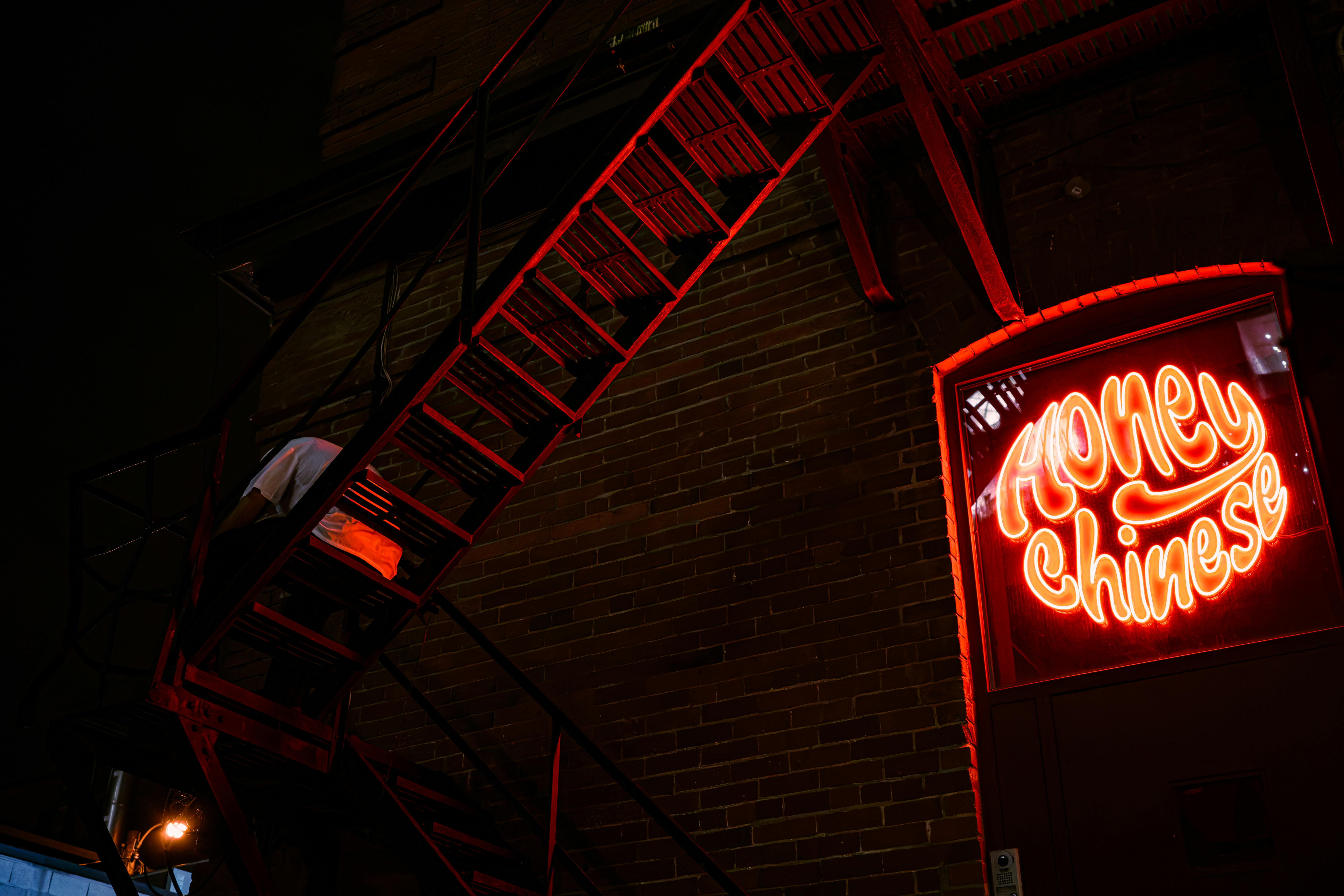 Neon Sign and Industrial Staircase in Night Glow
