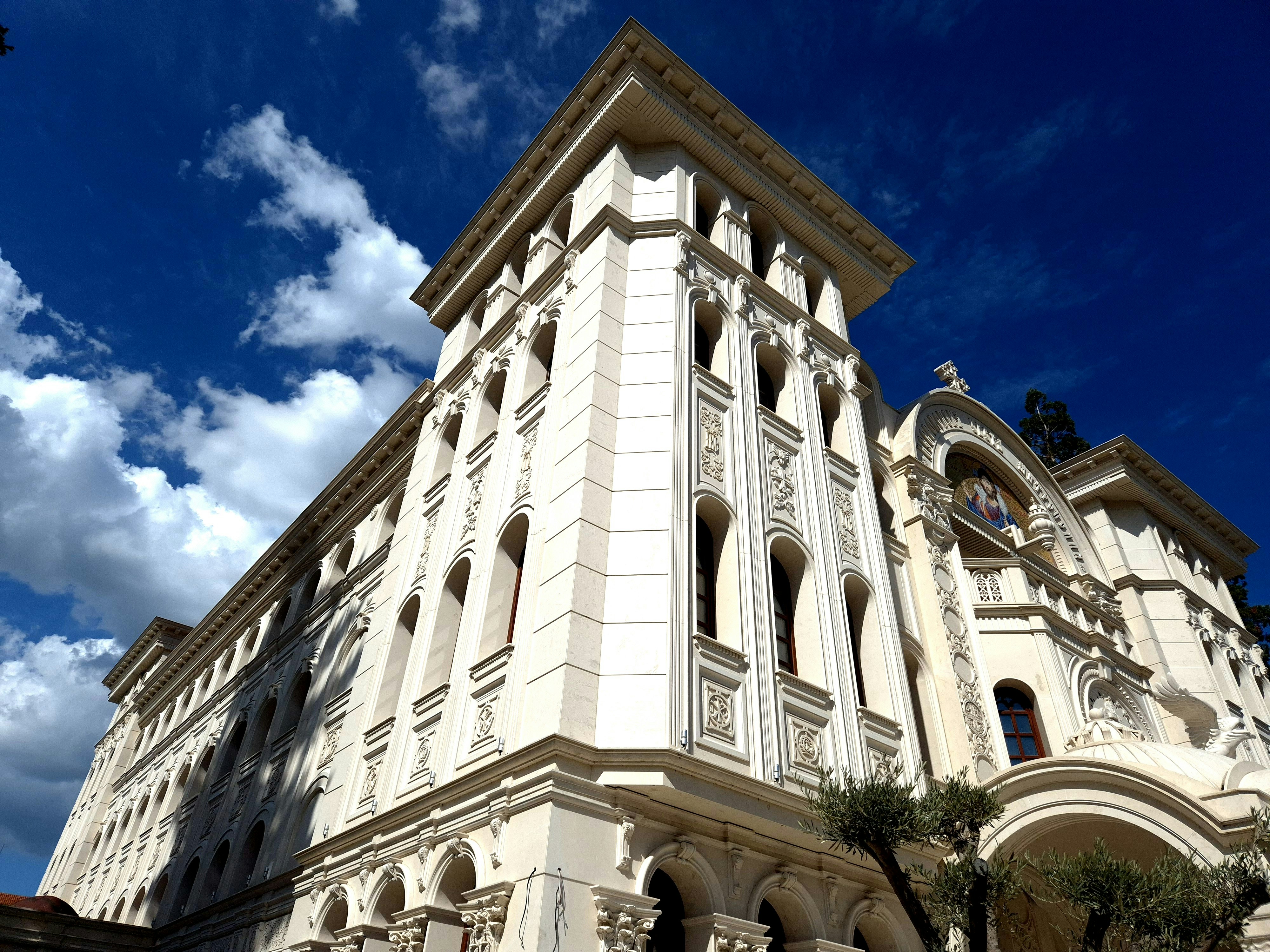 Sunlit Revival: an ornate neoclassical facade under a blue sky