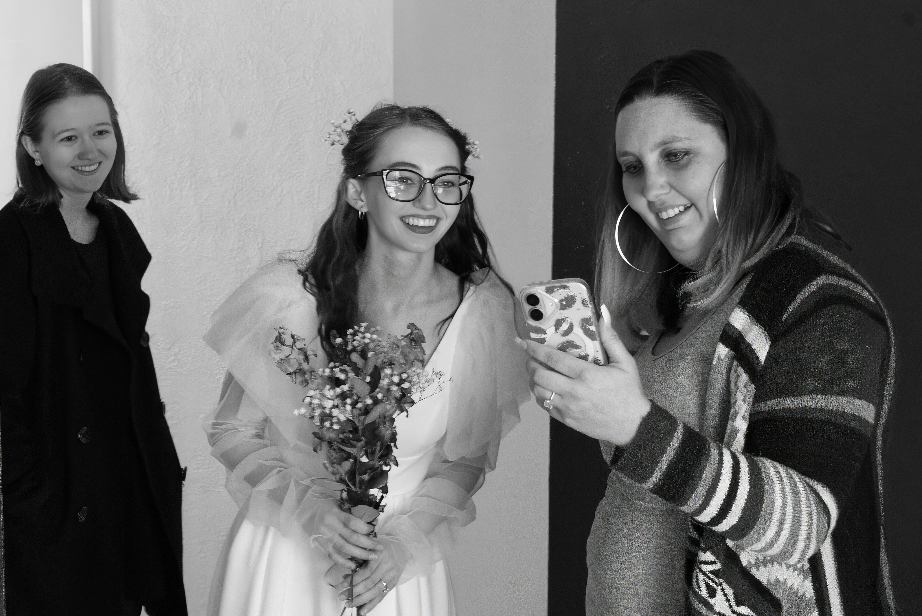 A Moment of Joy: Bride with Smile and Friend Captured in Black and White