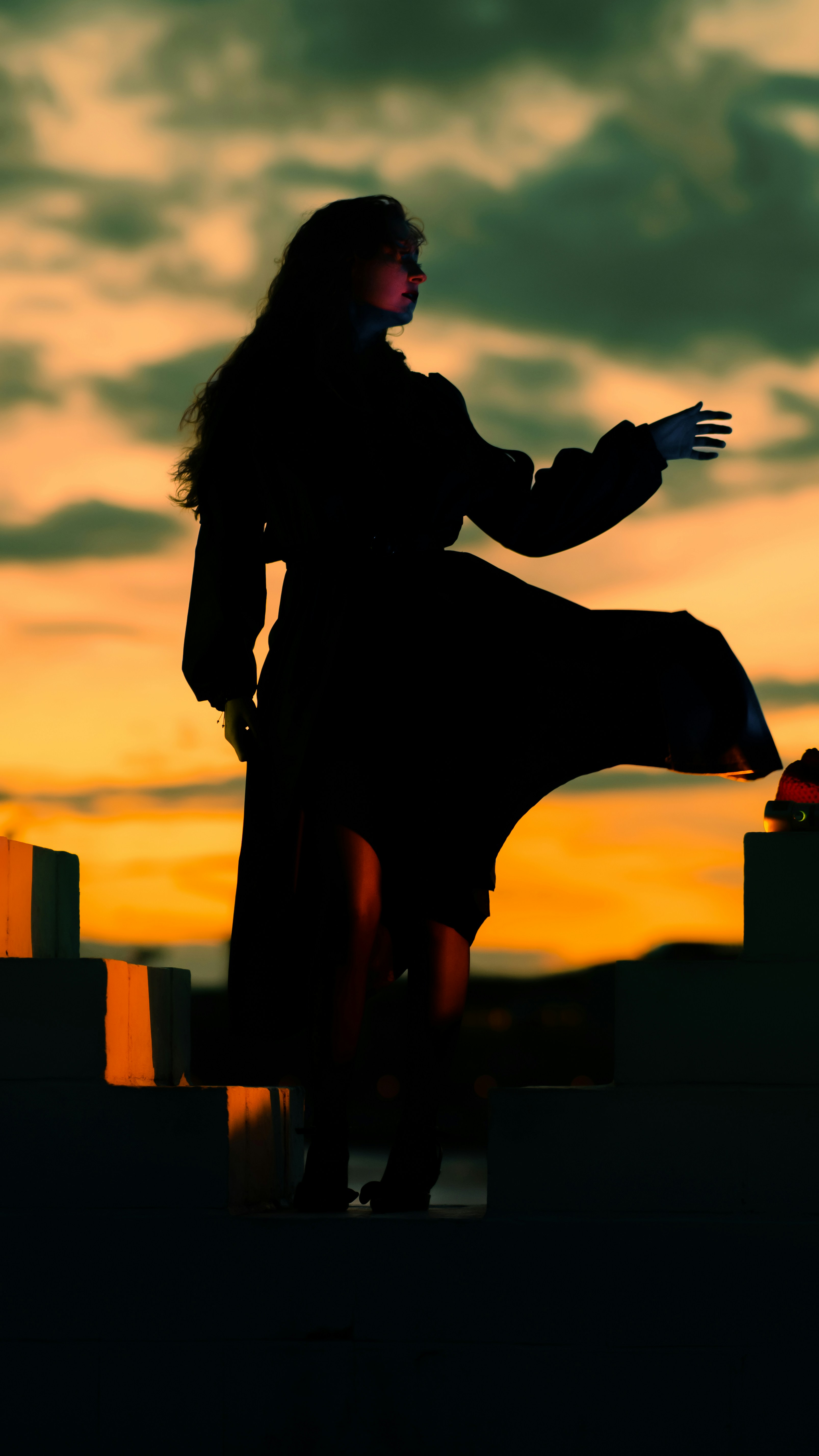 Silhouette in the Sunset: A Figure on Steps as Dusk Bares the Sky