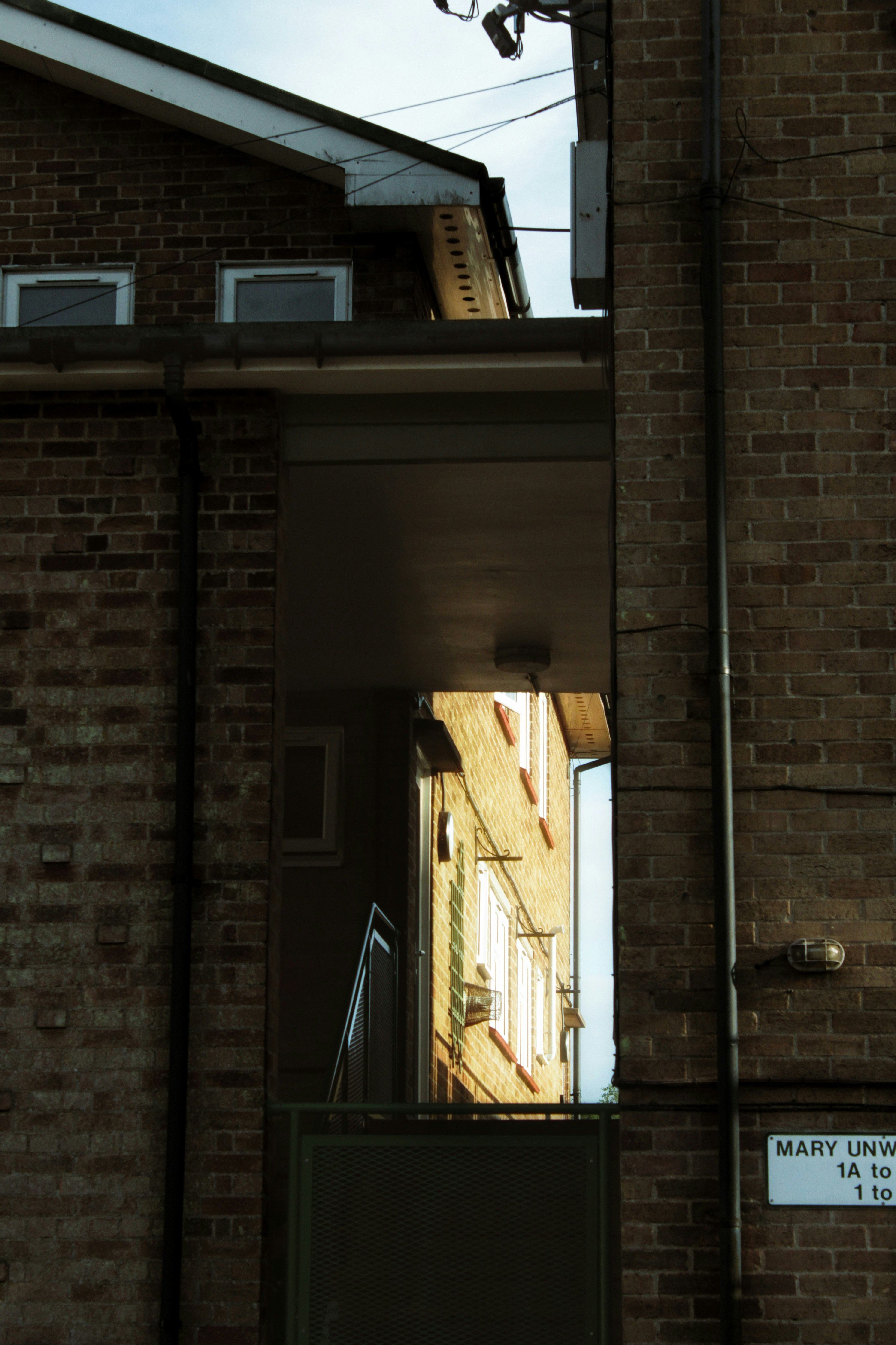 Between Brick Walls: A Narrow Alley Framed by Architecture
