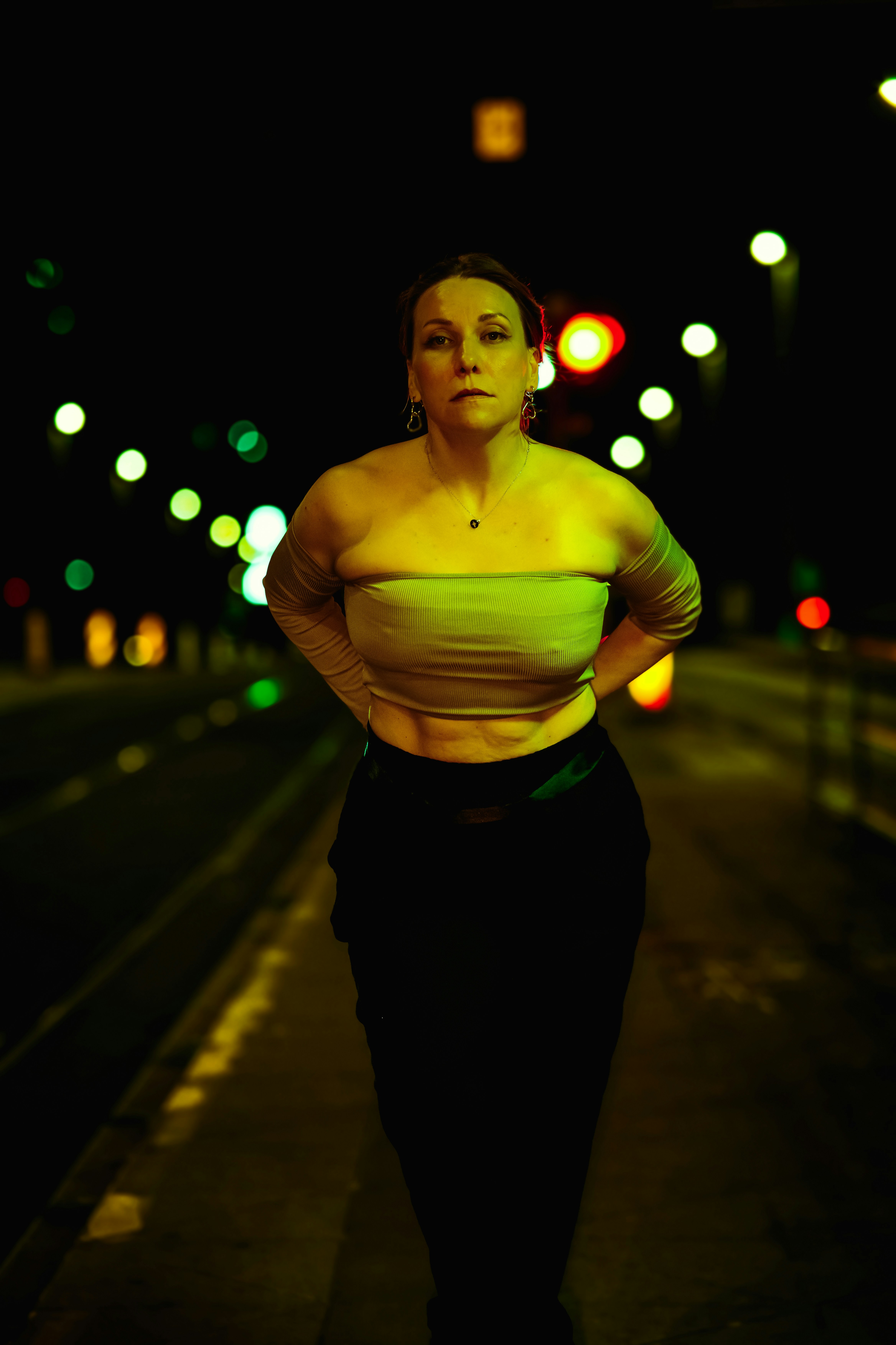 Midnight Stride: A Confident Gaze Under Neon Streetlights
