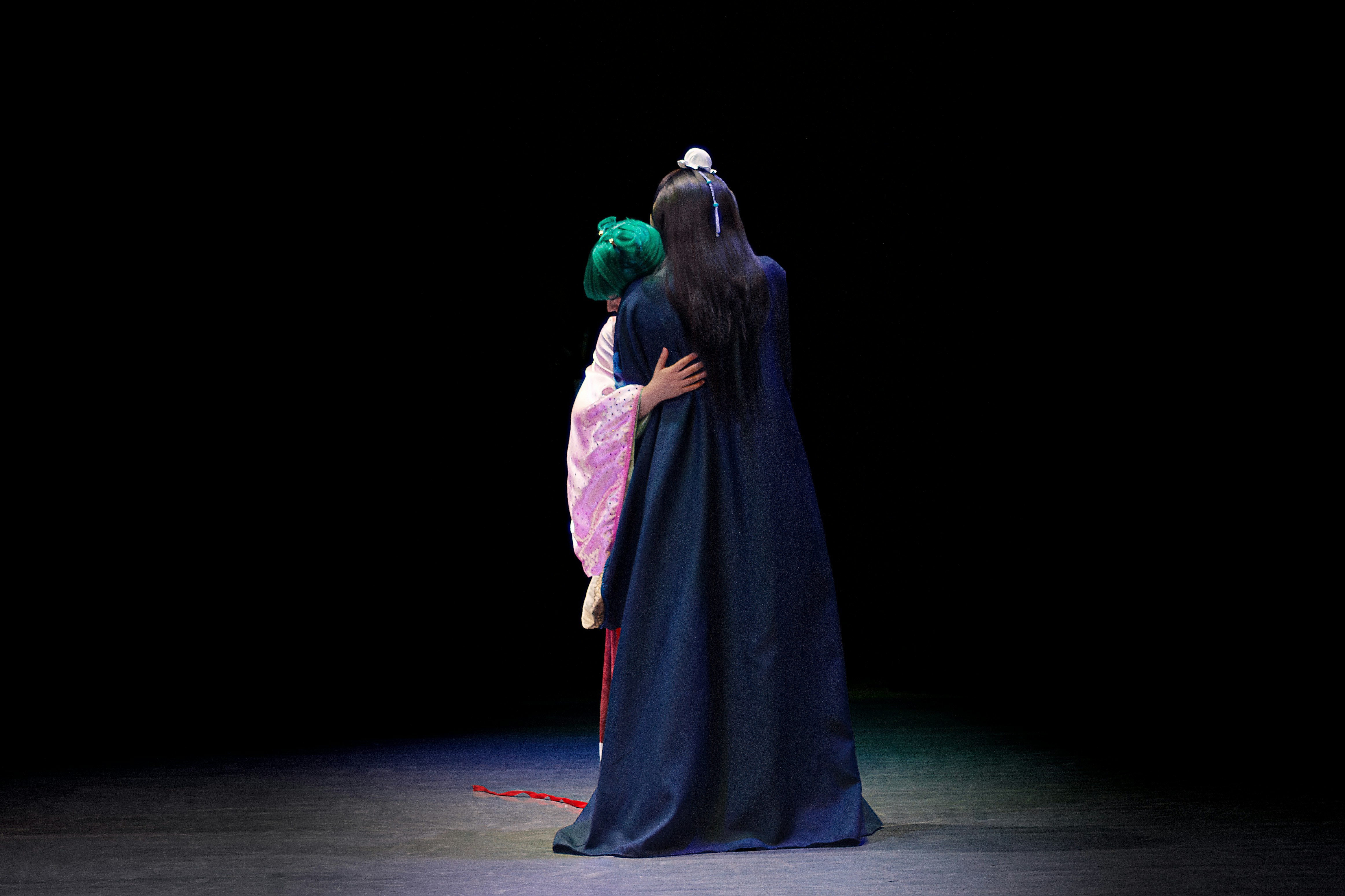 Silhouette of Union: A Quiet Embrace Under Spotlight