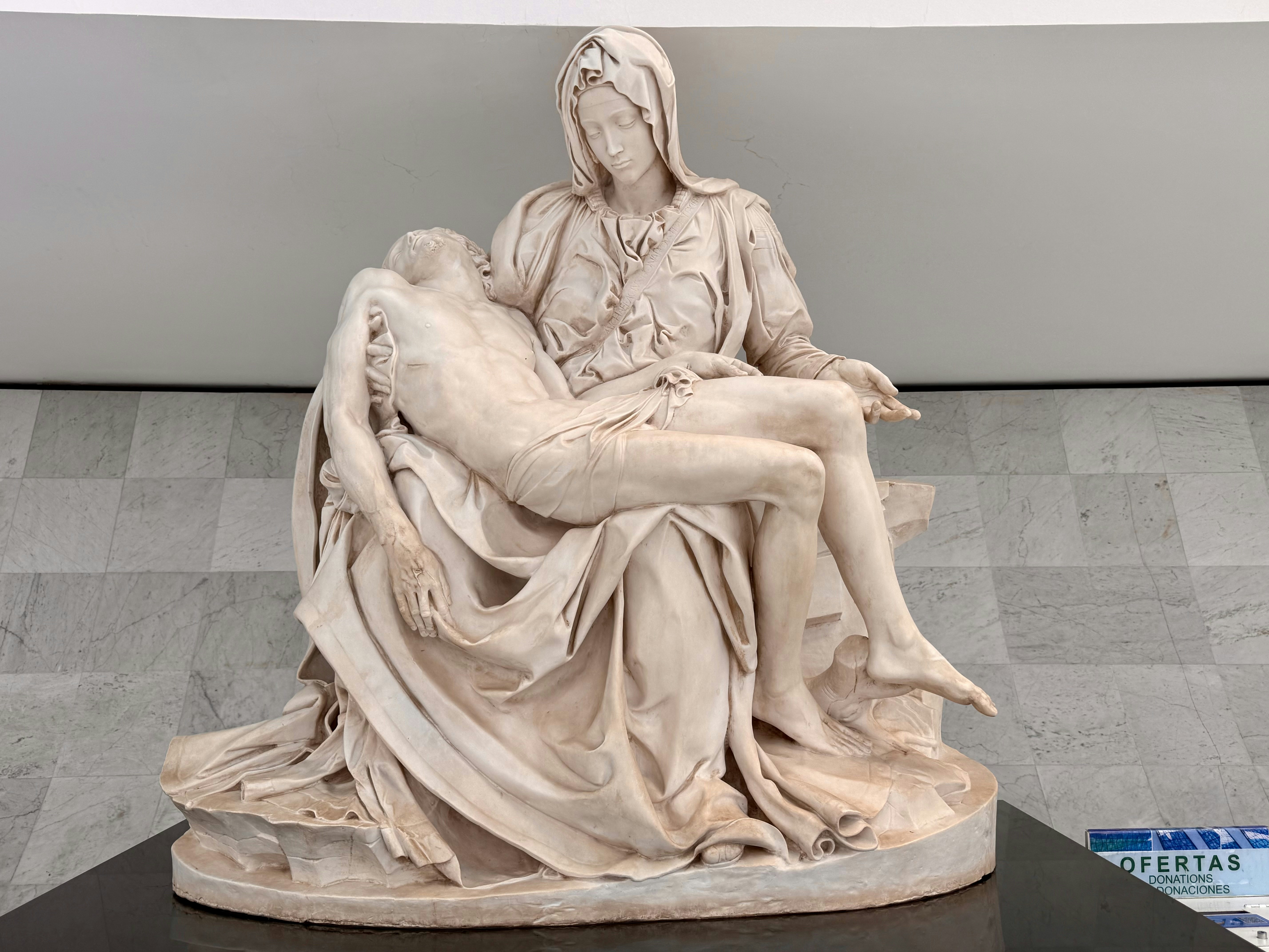 Stone Guardians: A Marble Pietà Beneath Neutral Light