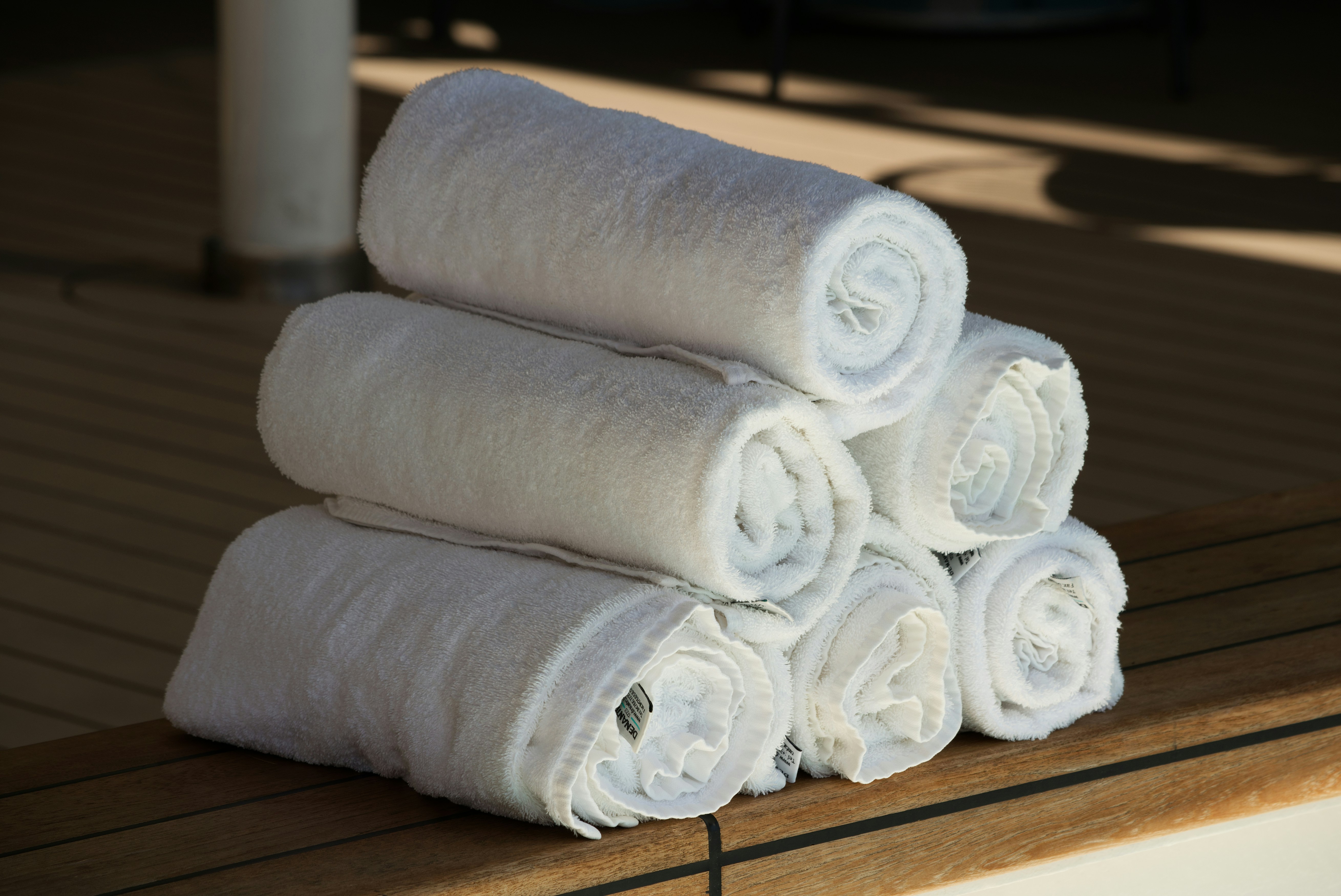 A Quiet Stack of Towels on a Wooden Deck