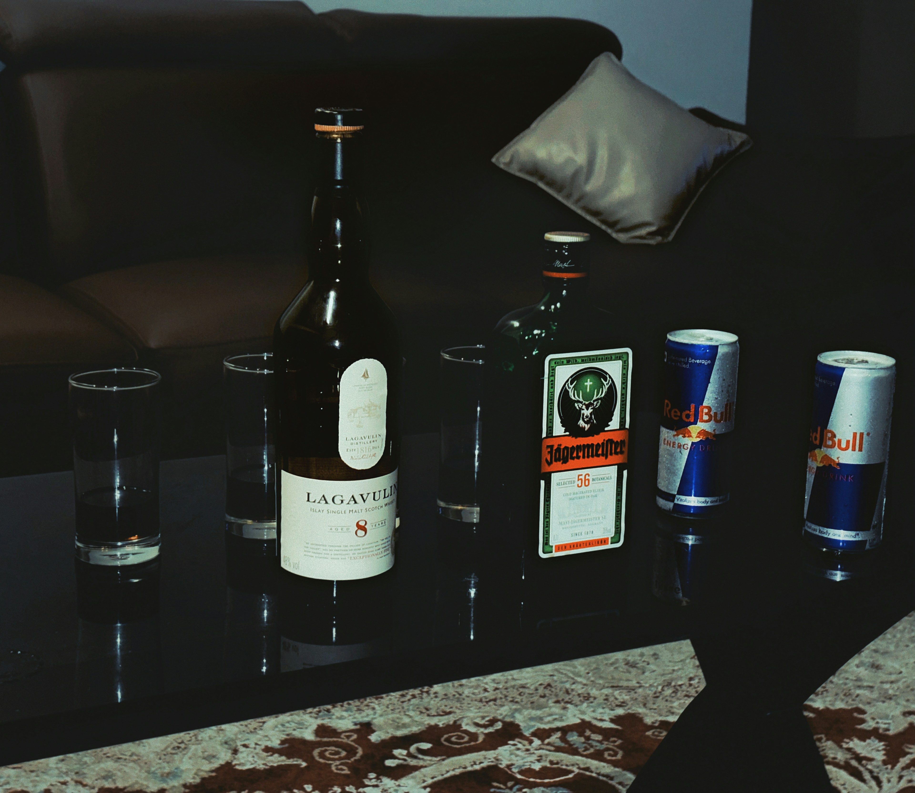 Midnight Spill: Bottles and Red Bull in Low Light